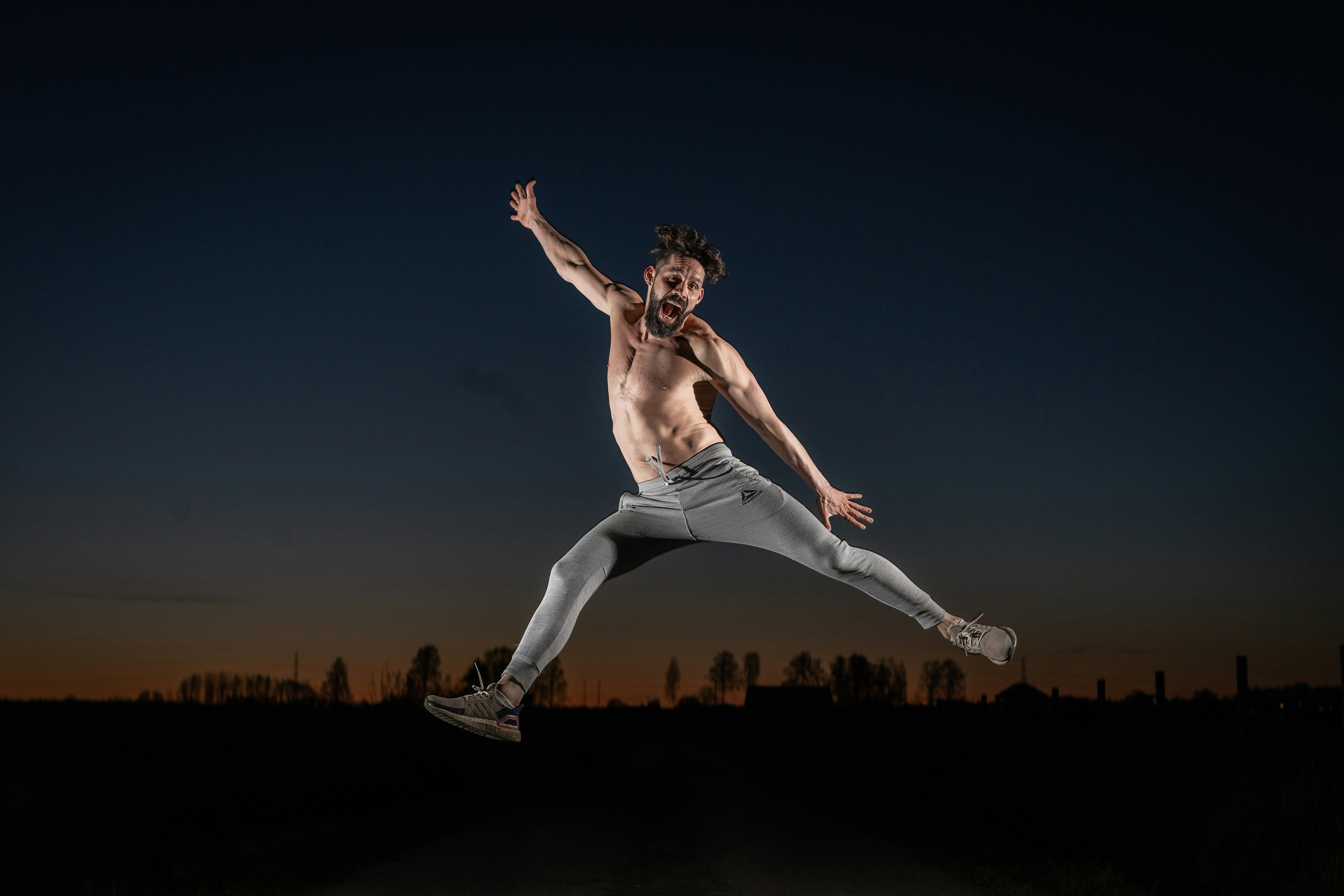 Leap of Night: A Freerunning Silhouette Soars Across the Horizon