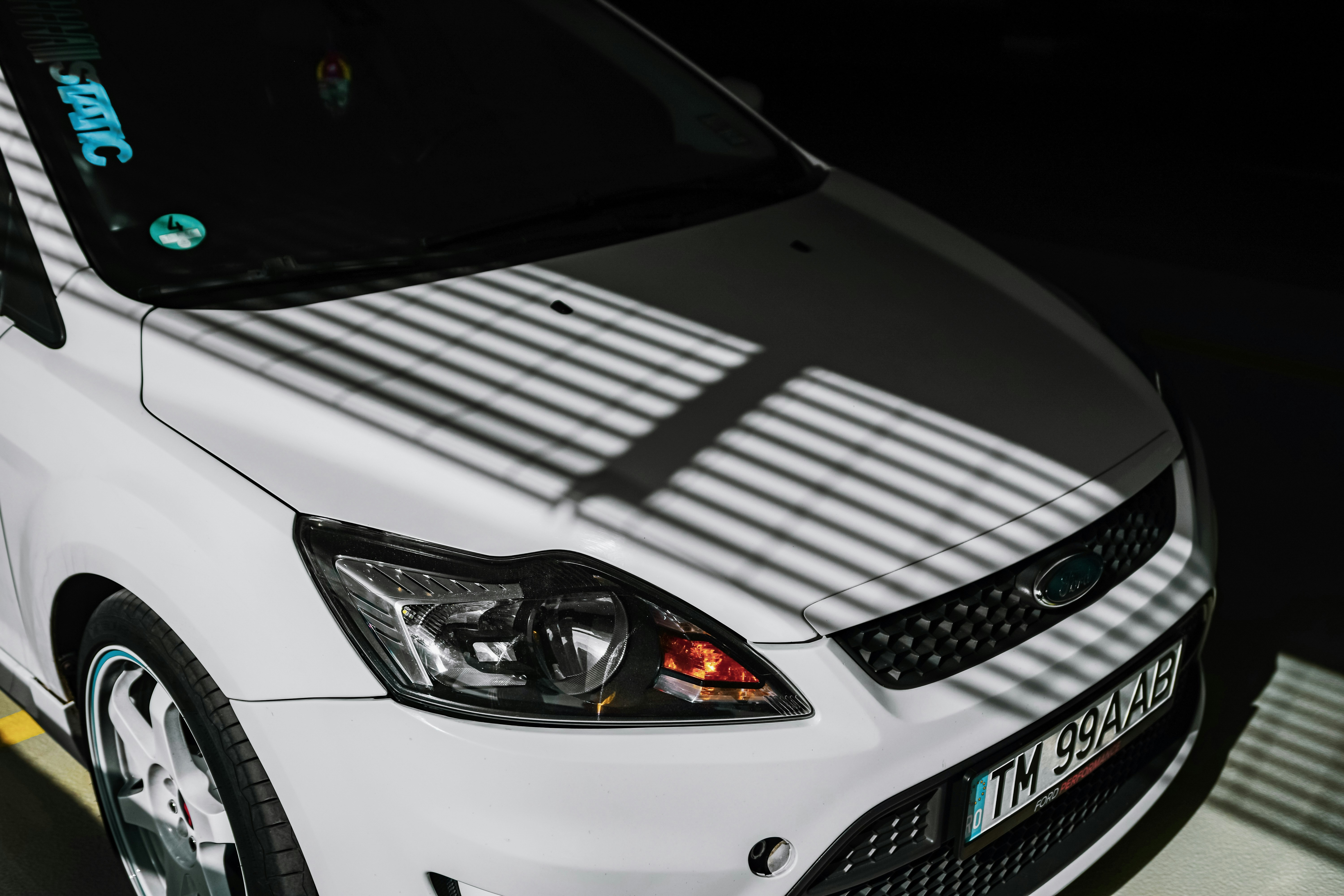 Front-Quarter Stripes: Light Dance on a White Ford
