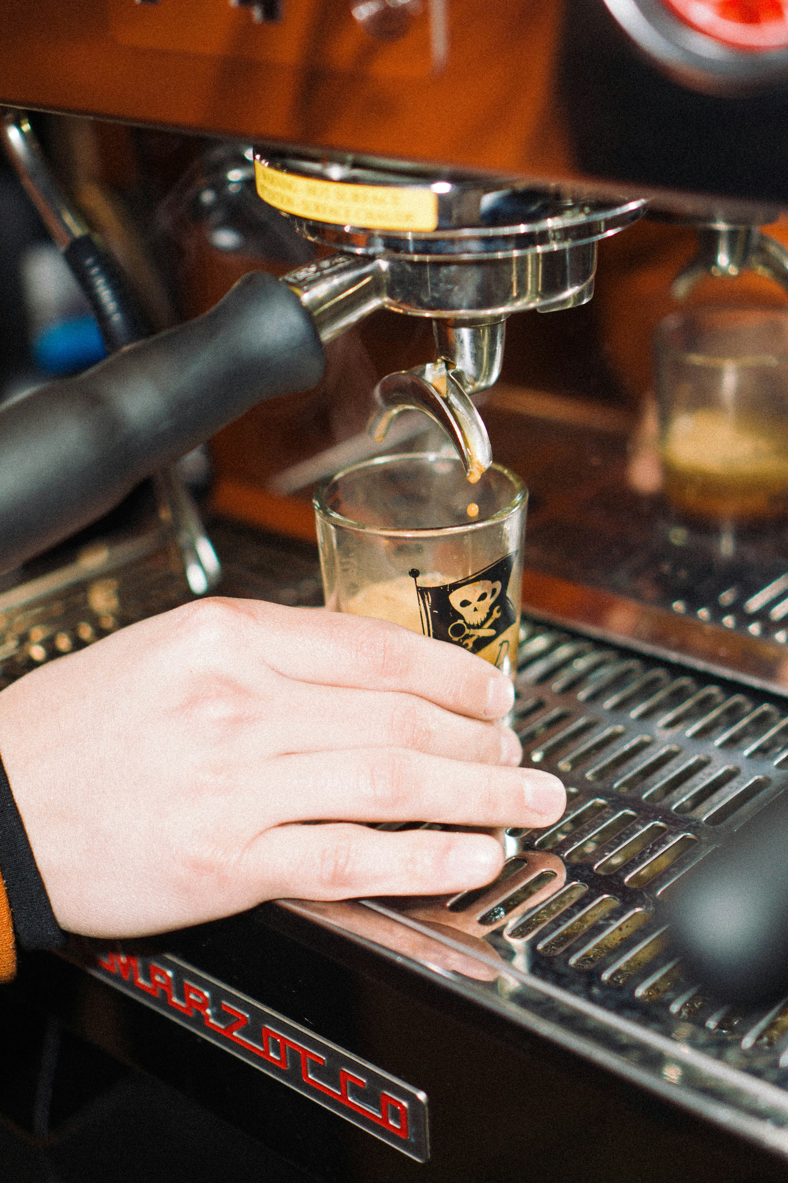 Hand on Ice-Cooled Shot: A Barista’s Pour Under Pressure