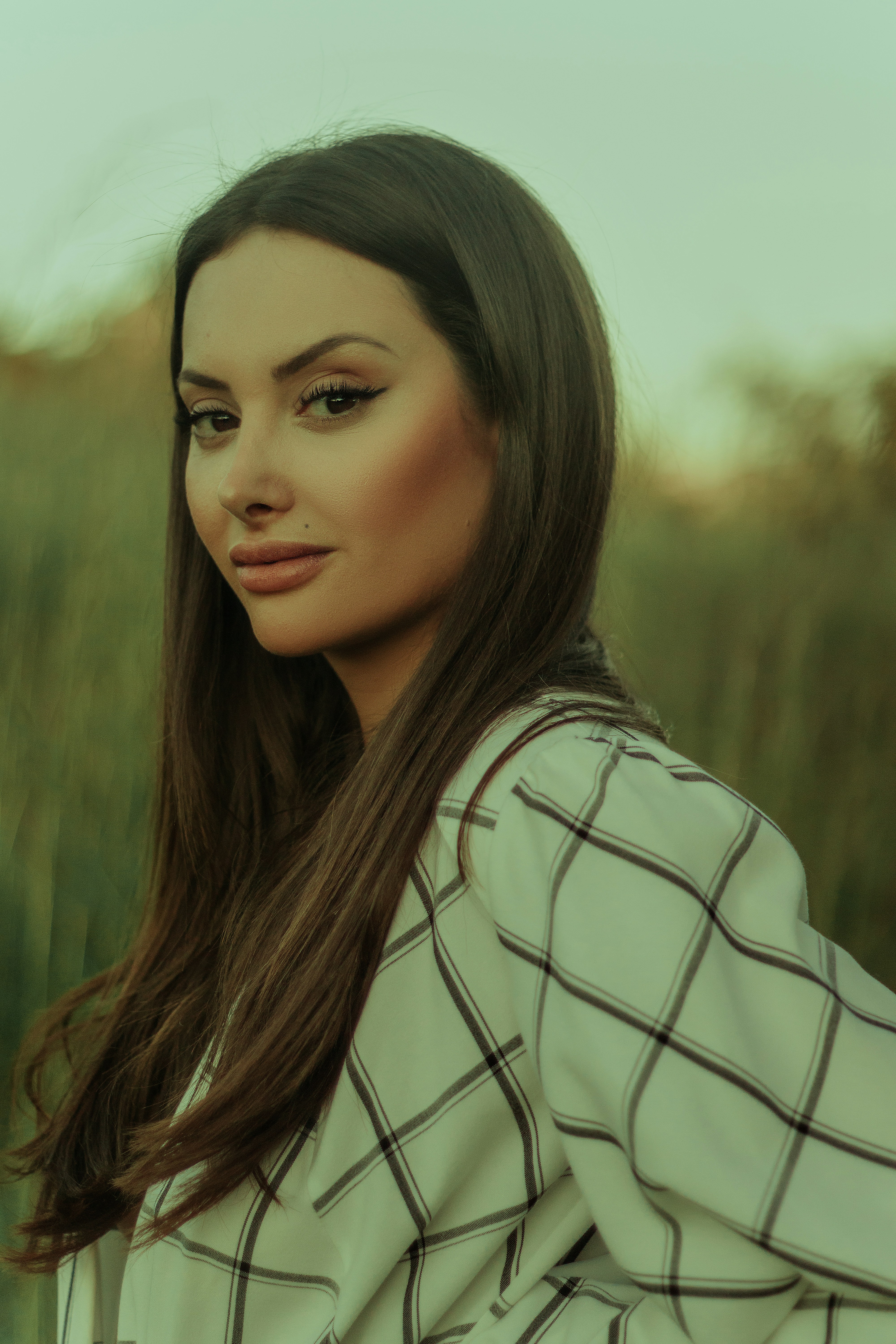 Emerald Echo: a poised portrait in a sunlit meadow