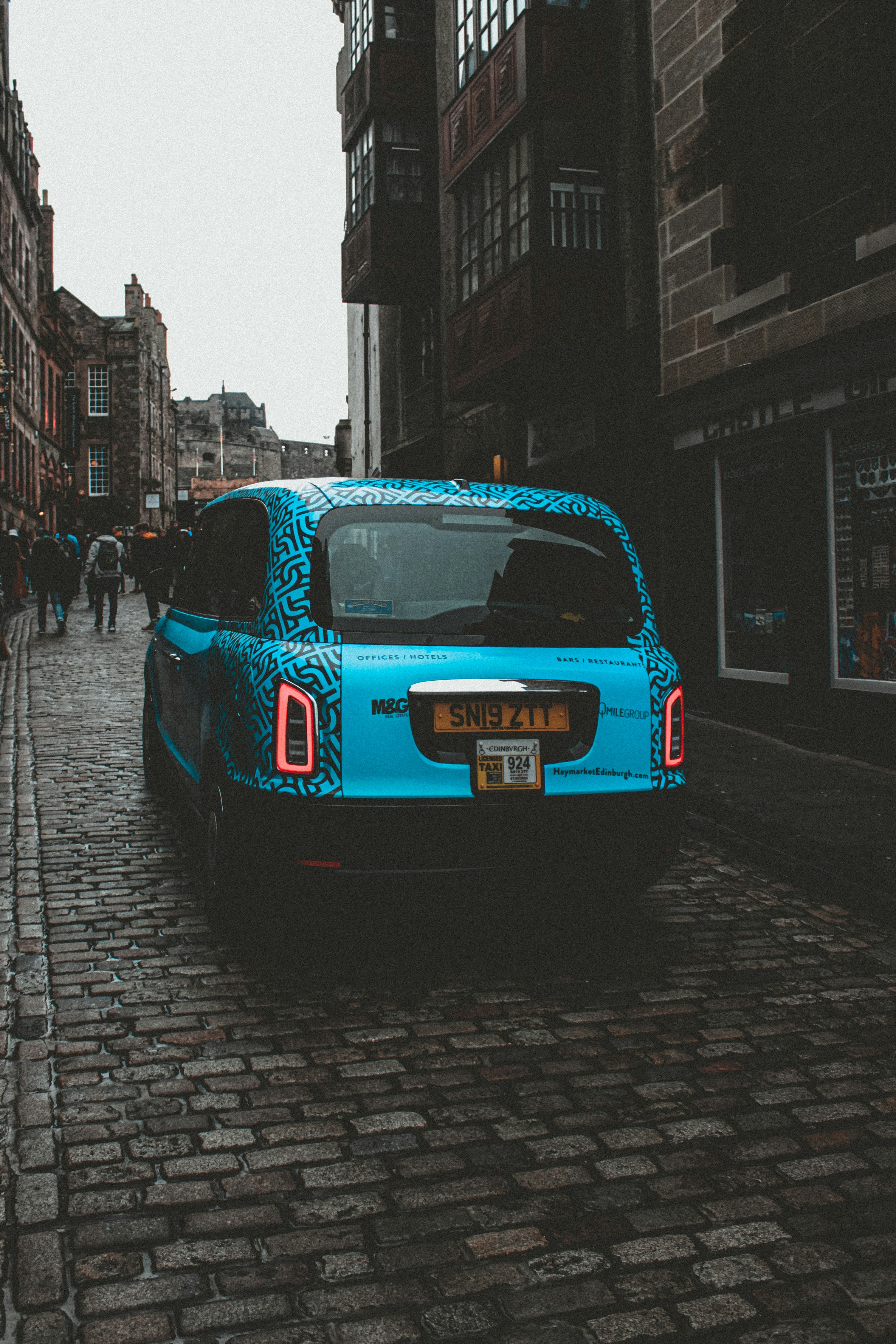 blue volkswagen beetle parked on sidewalk during night timeMathias Reding