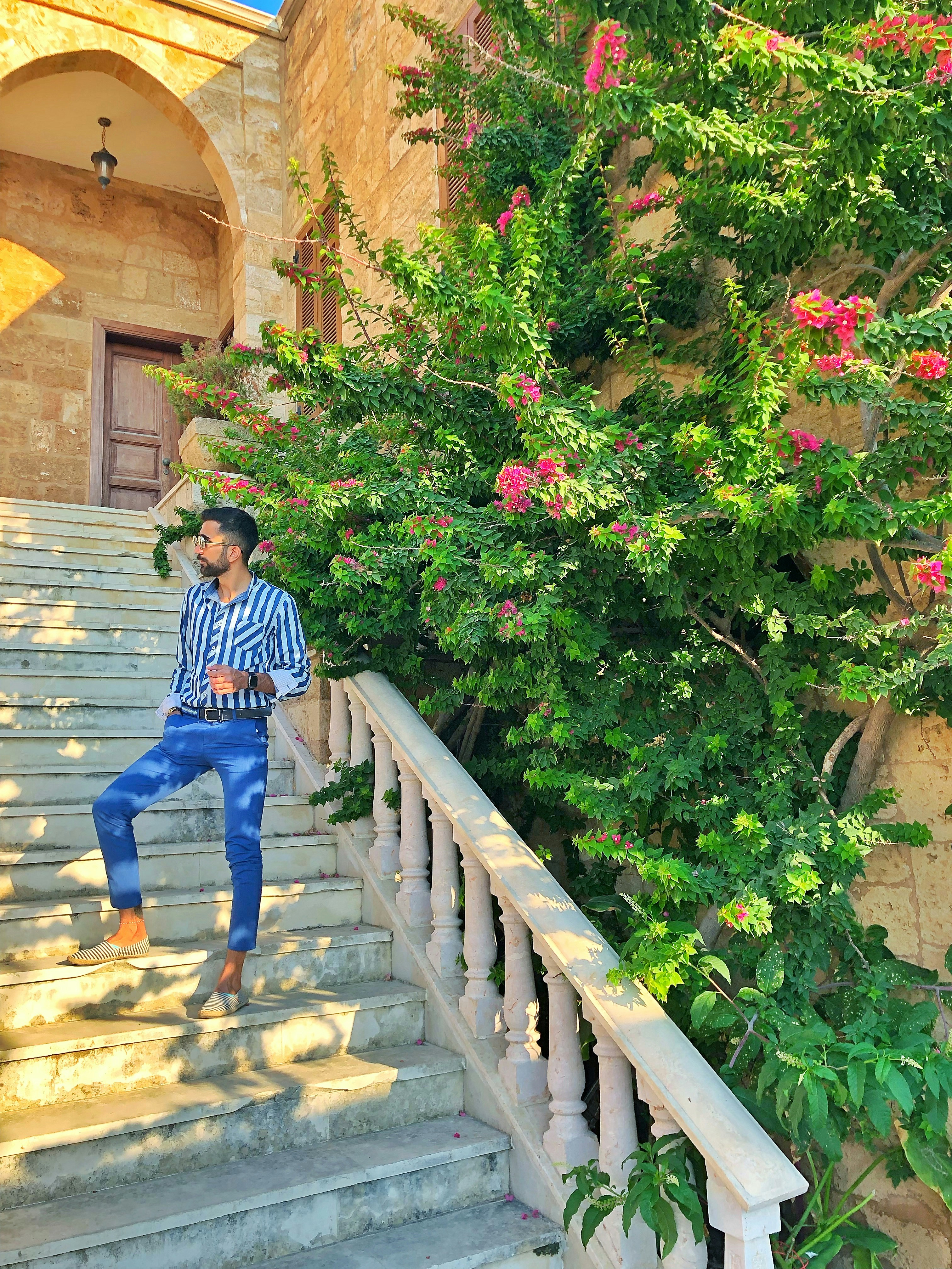 Boy in blue and white stripe shirt and blue denim jeans standing on ...