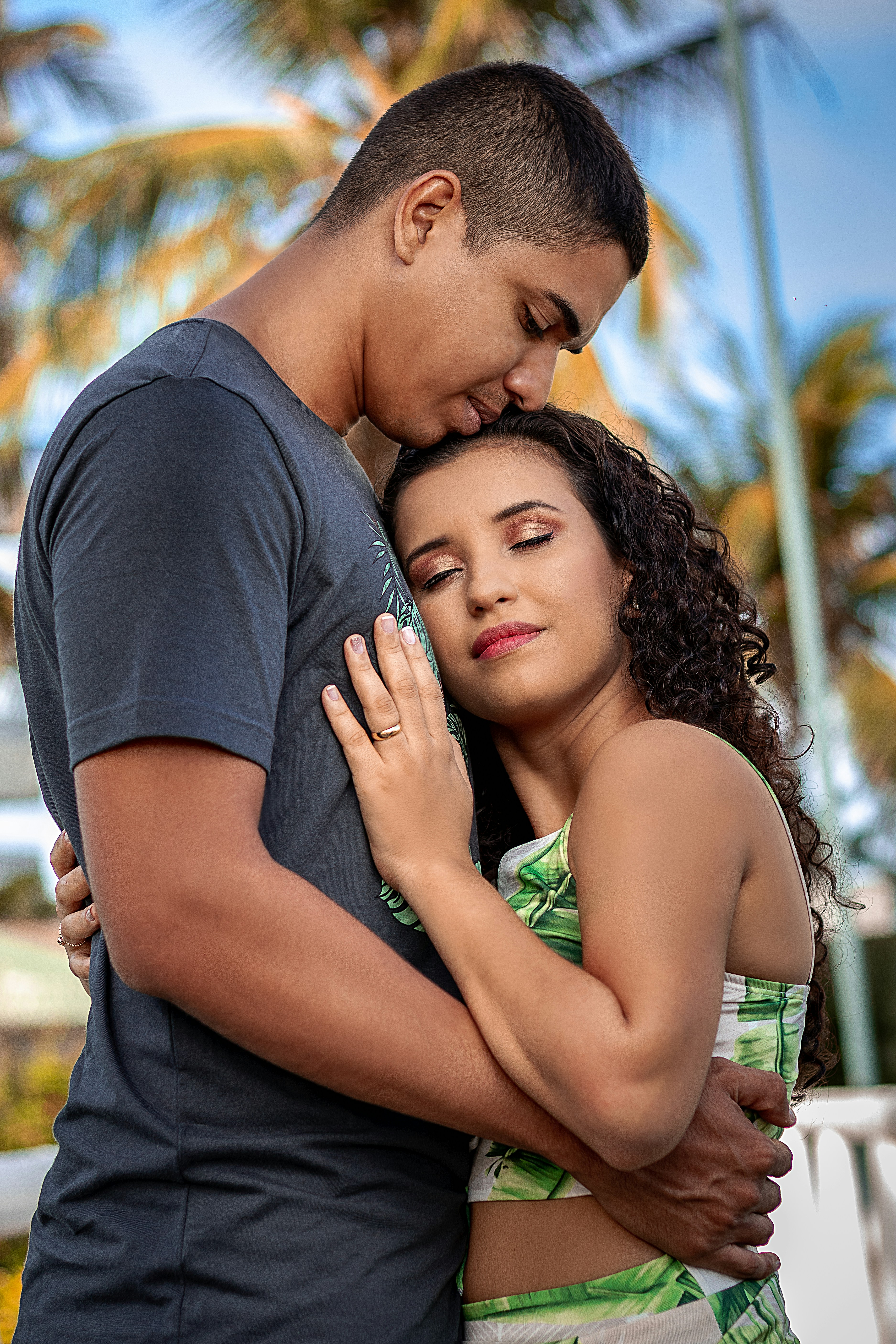 Man in black crew neck t-shirt kissing woman in green tank top photo ...