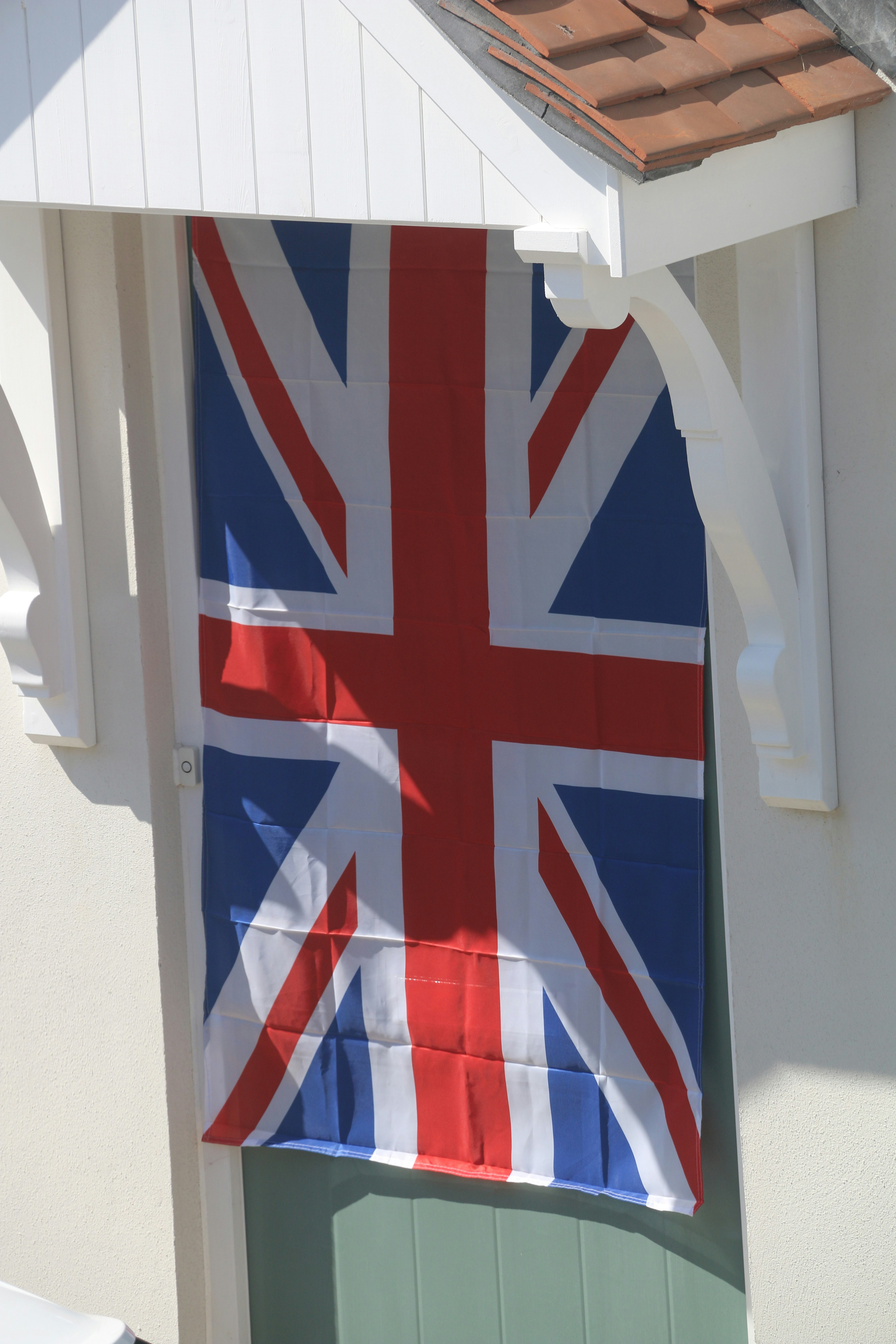 Union Jack flag draped elegantly over a door, highlighting national pride and tradition.