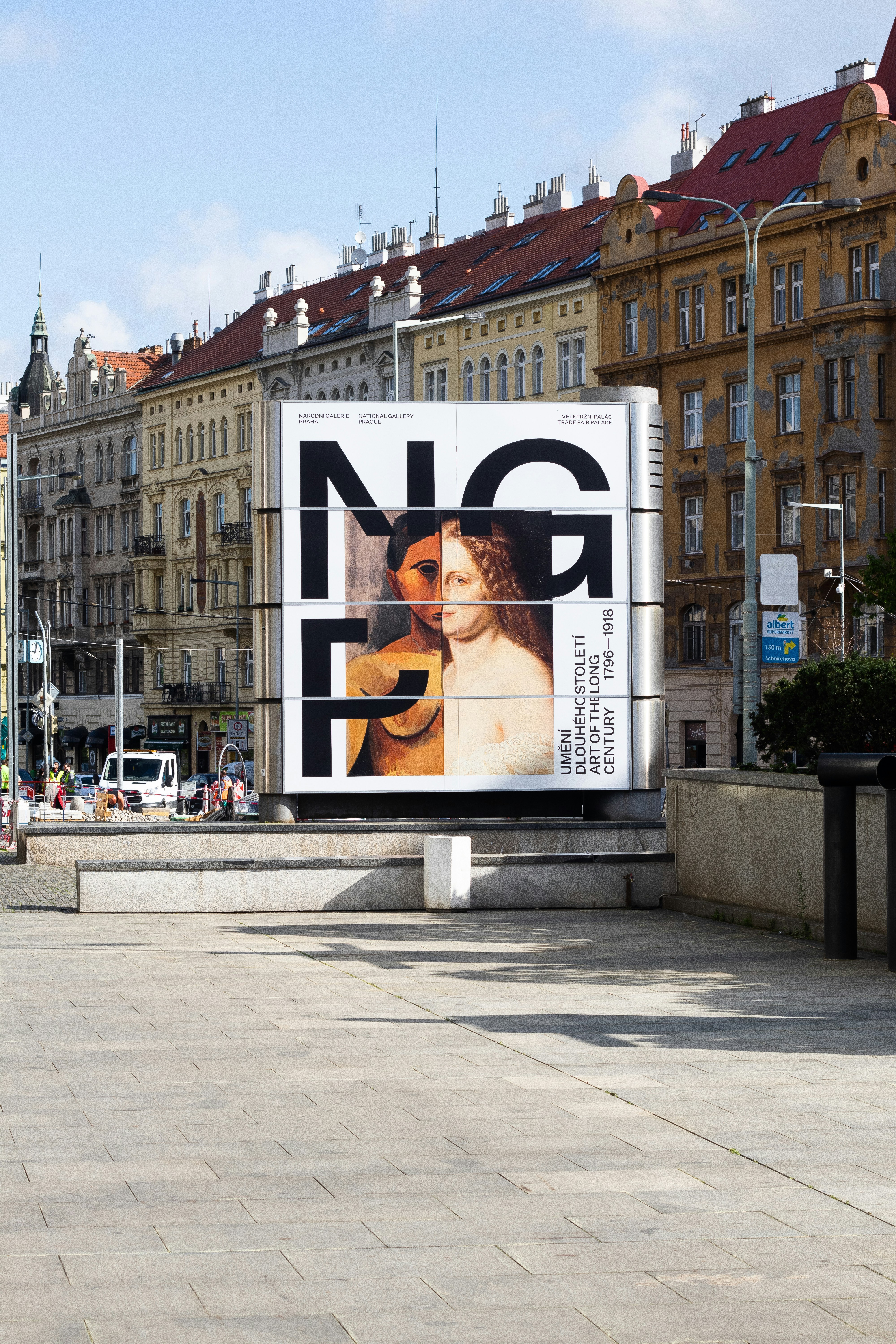 woman in orange dress standing on sidewalk during daytime