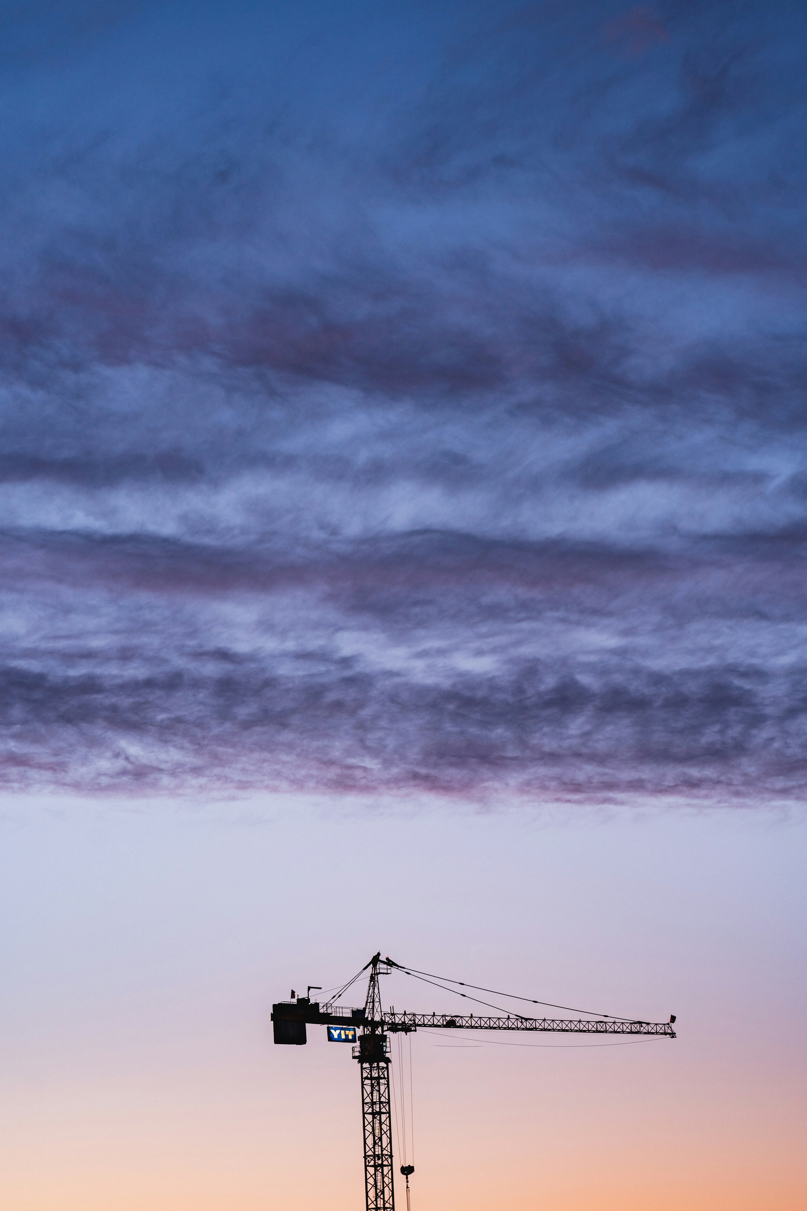 Crane Silhouette at Dusk Over a Quiet Horizon
