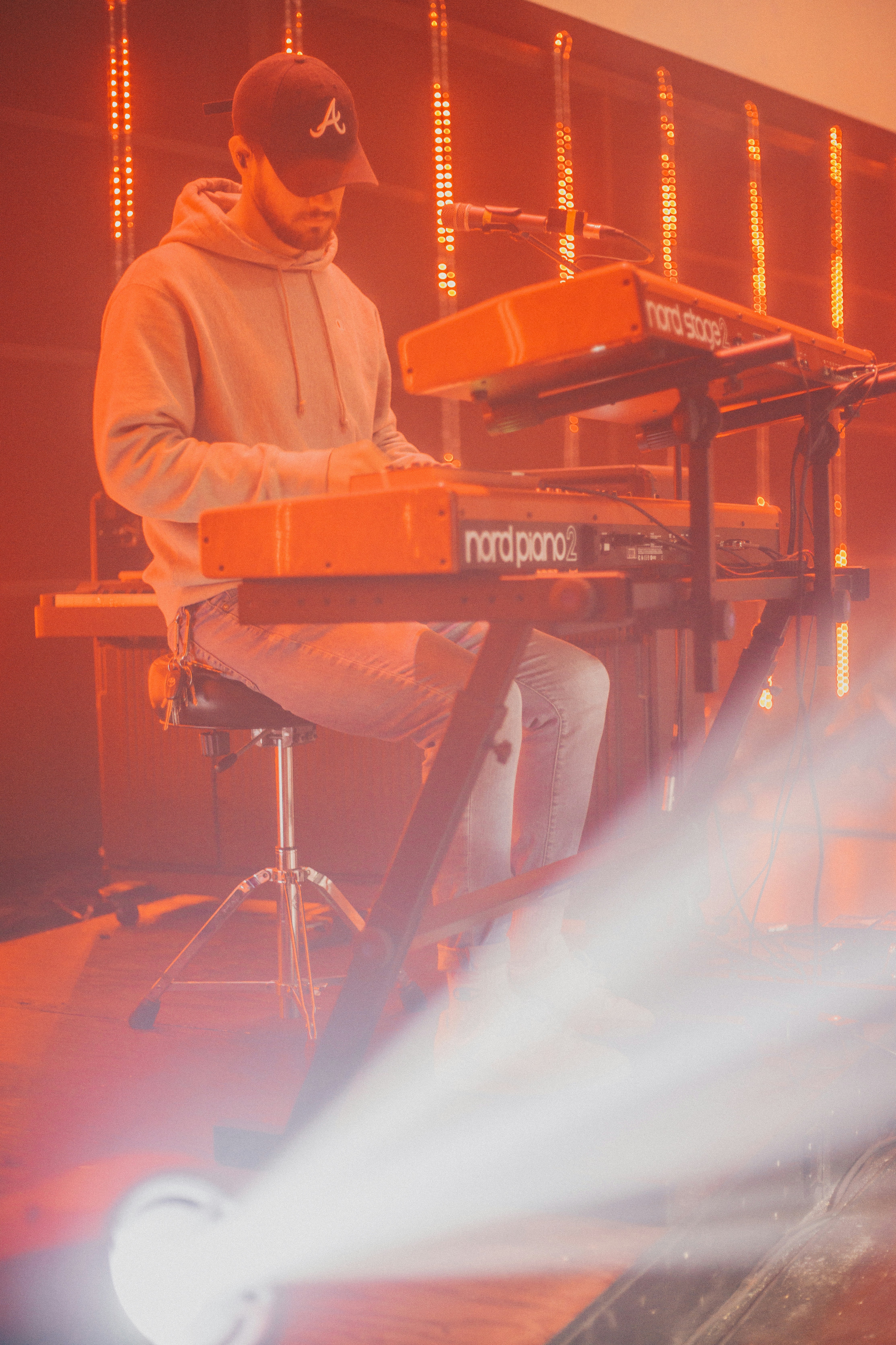 Amber Pulse on Stage: A Keyboardist Wrapped in Neon Haze