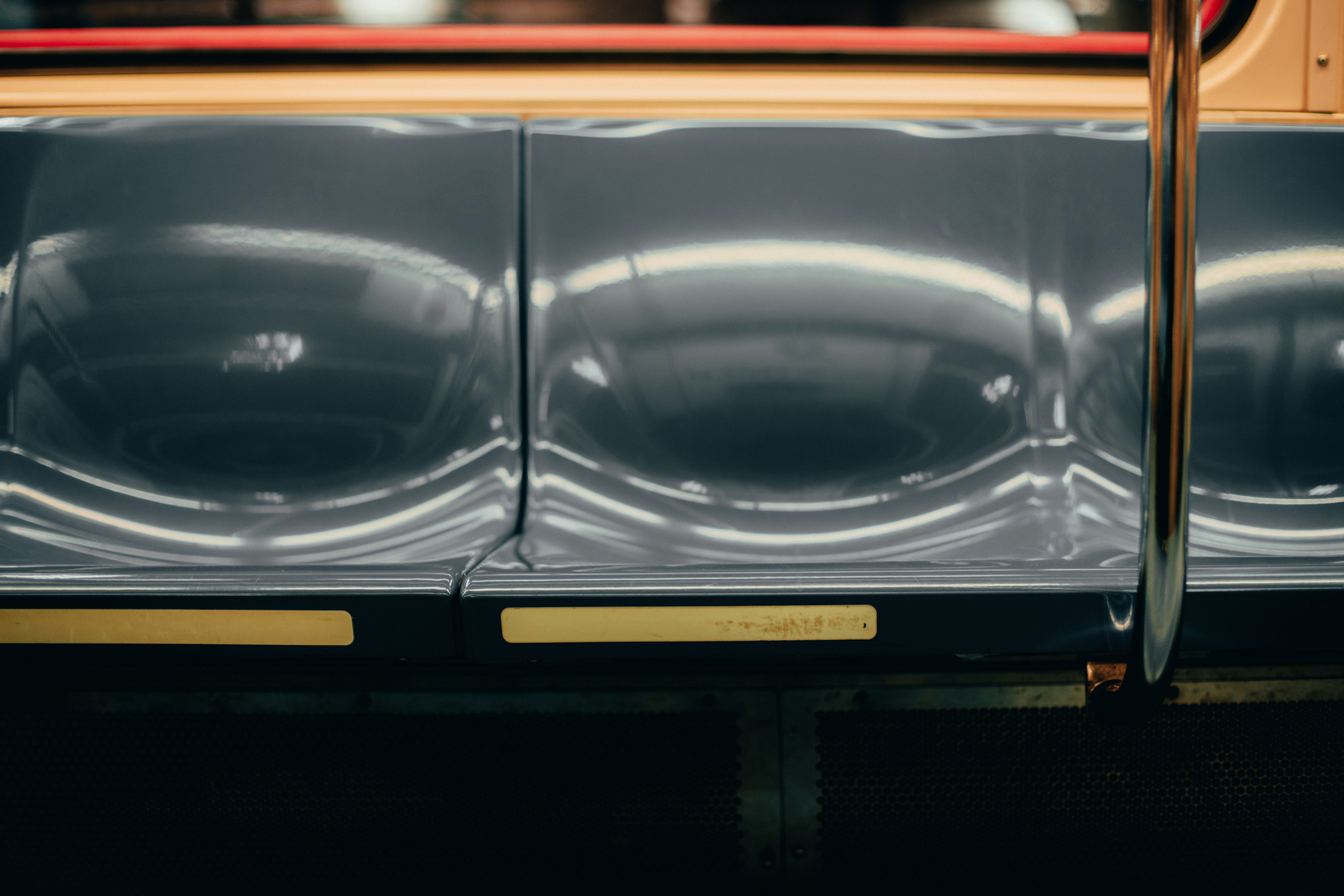 Chrome Rail and Saddle: A Vintage Bus Seat’s Quiet Symmetry
