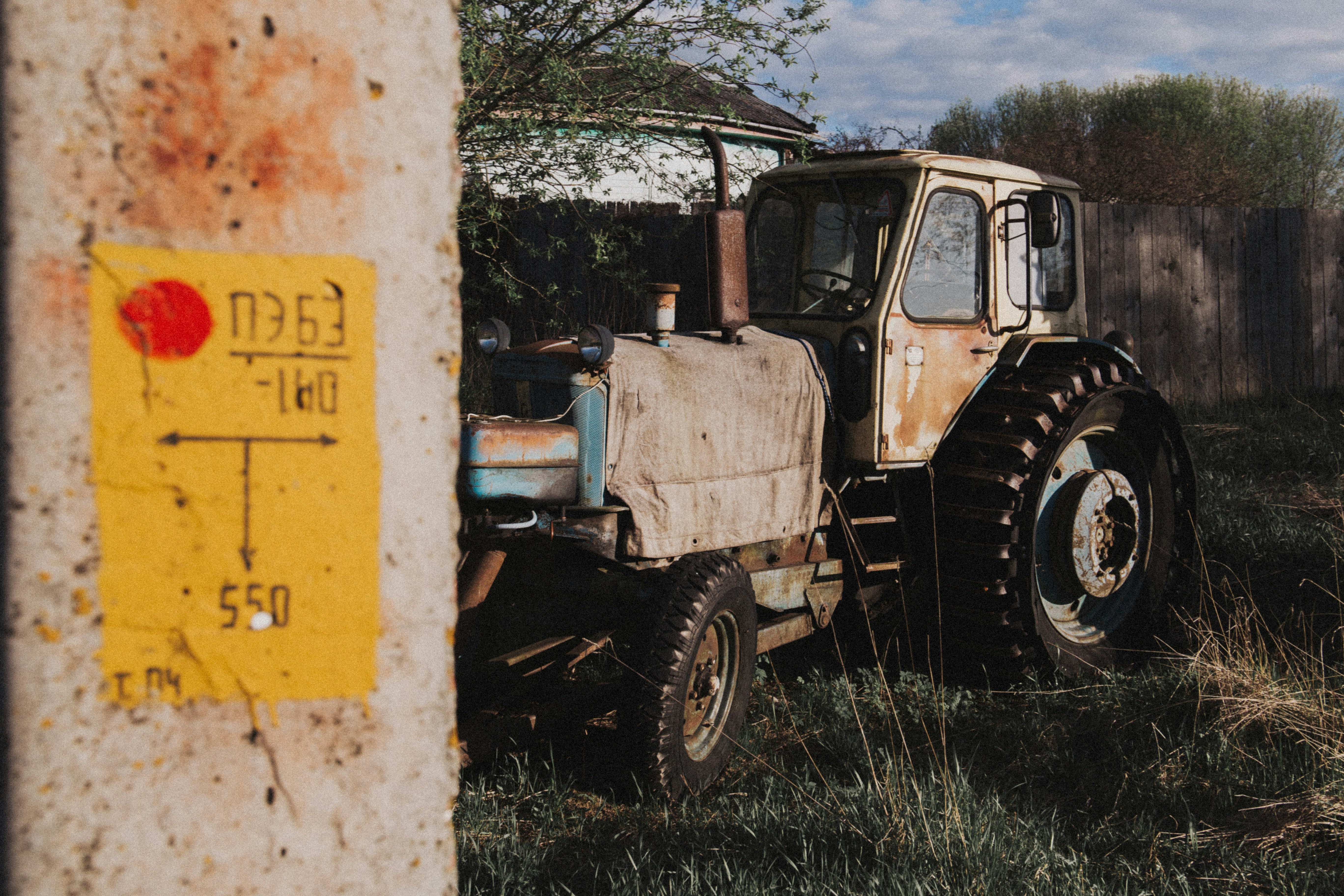 blue and brown tractor on green grass field during daytime