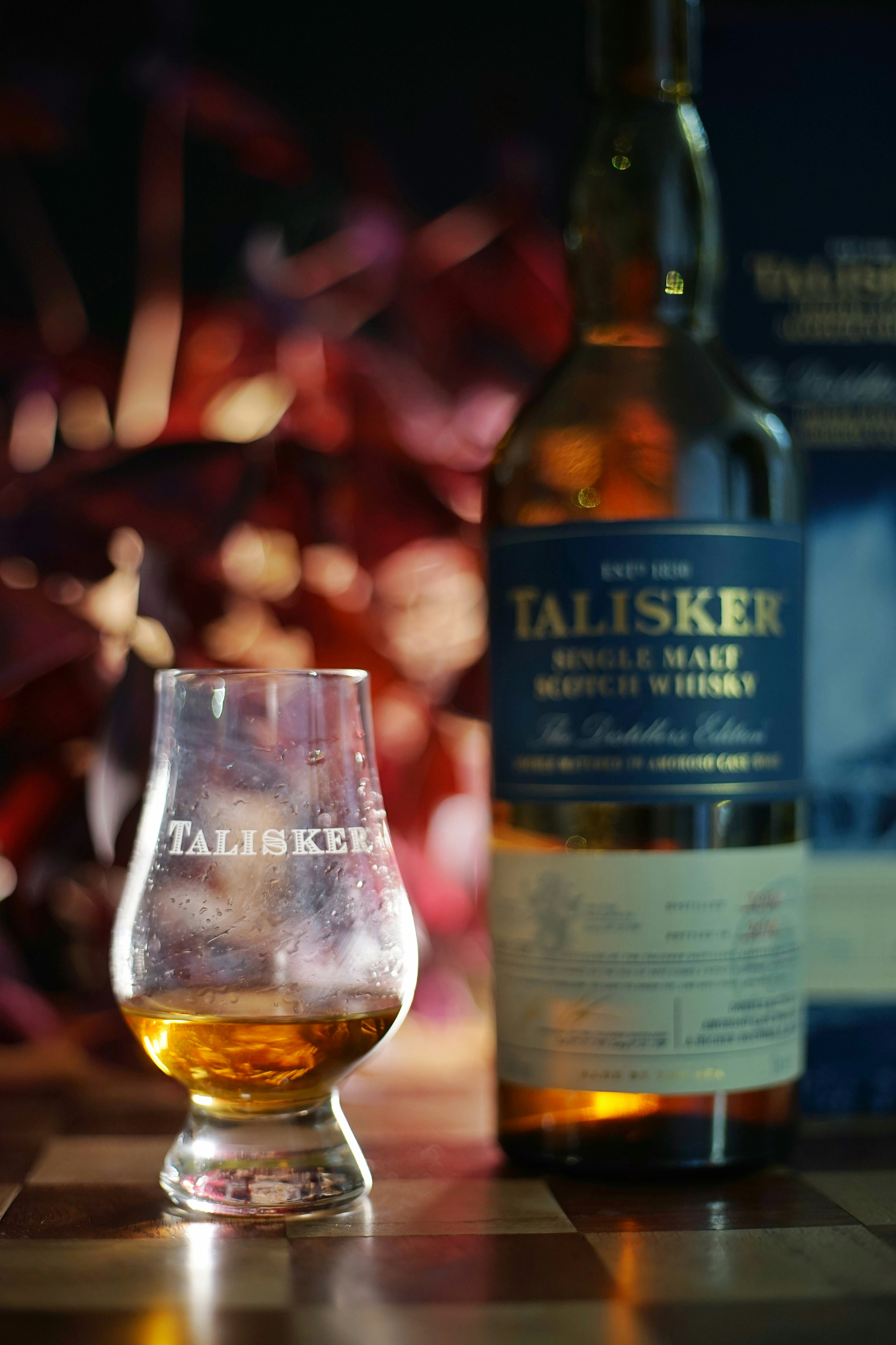 Whiskey Glass in Focus, Bottle in the Blur