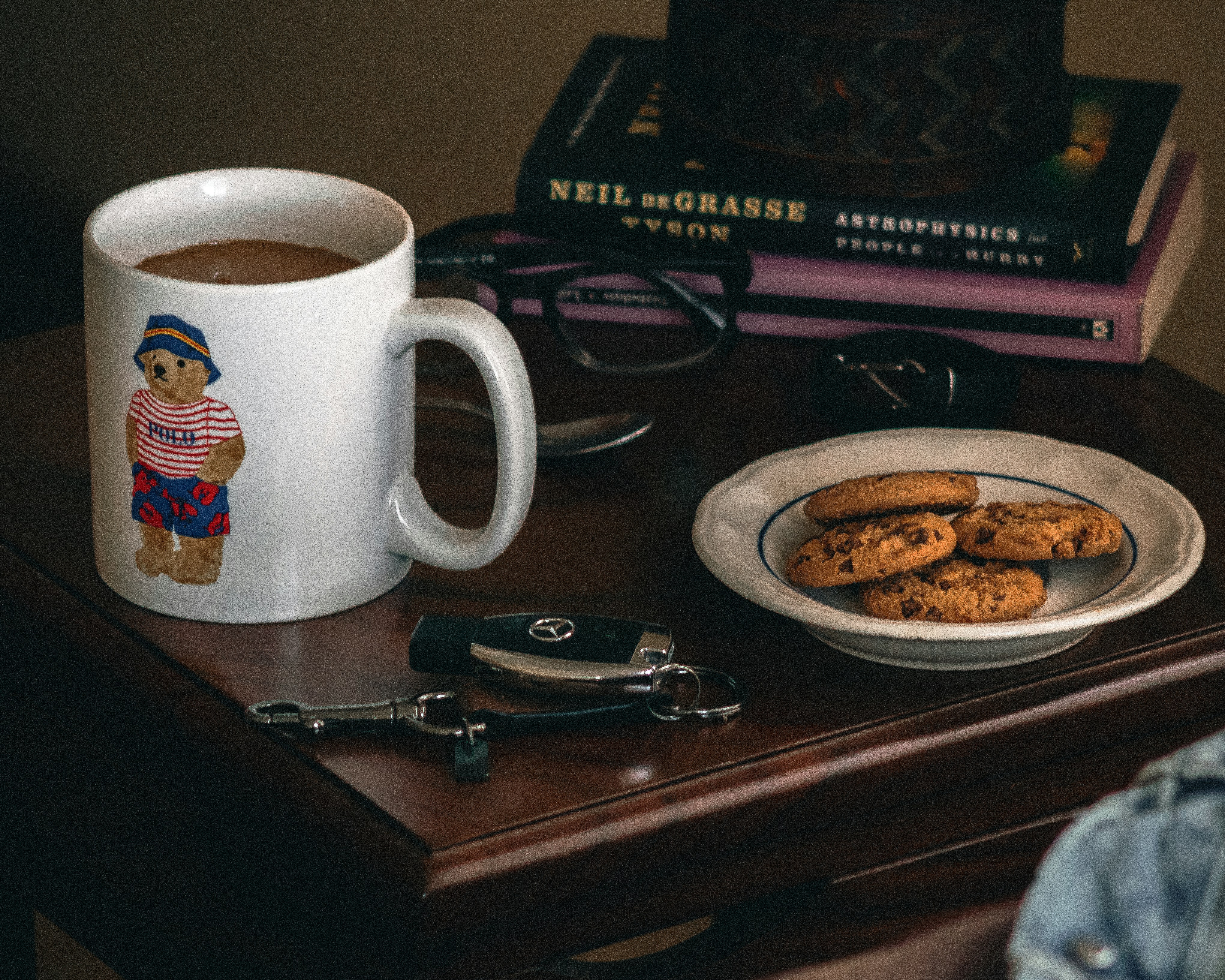 Cafe Corner: A White Mug, Cookies, and Keys on a Wooden Desk