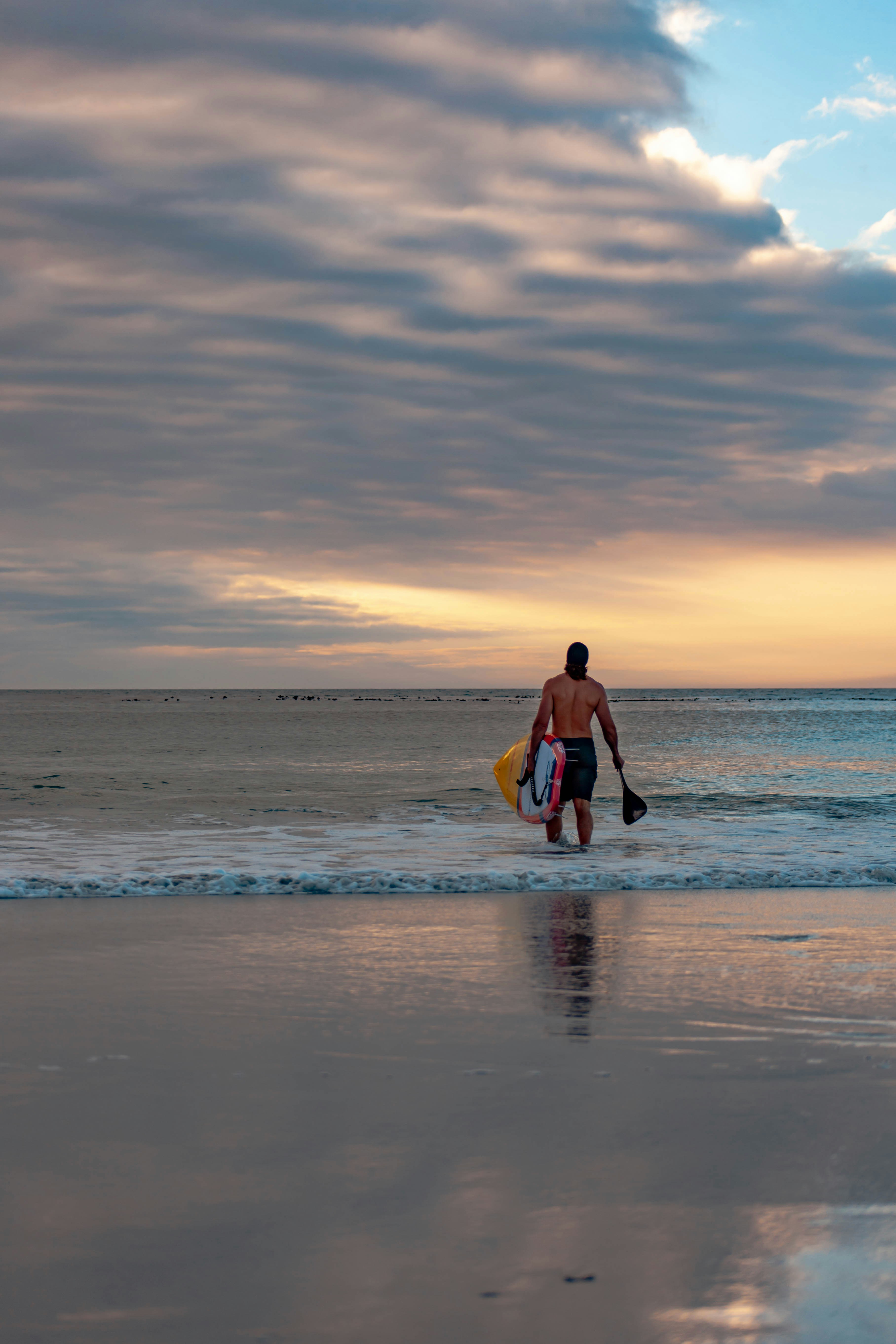 Horizon Walker: Surfer's Silhouette at Golden Hour