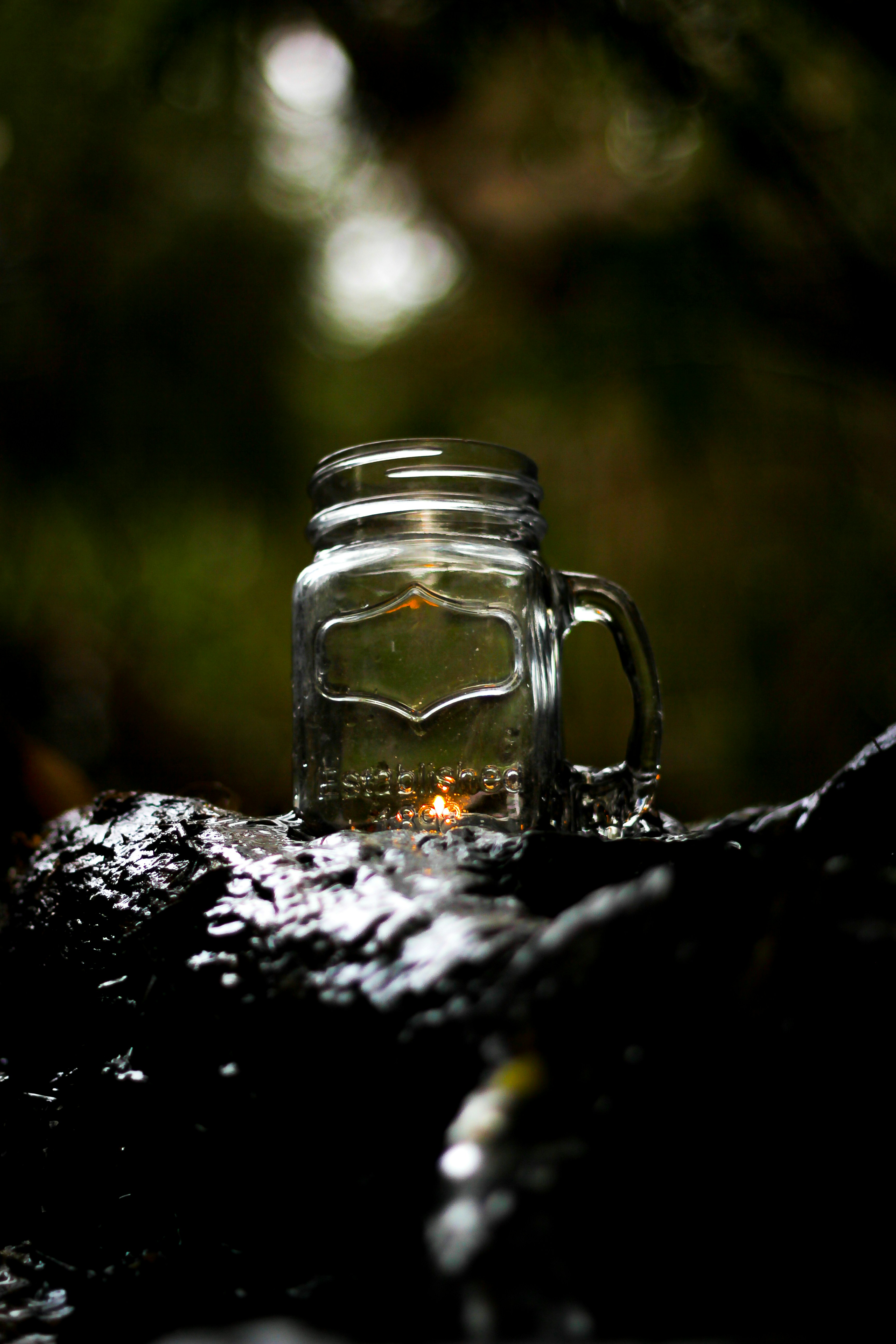 clear glass mug on black rock