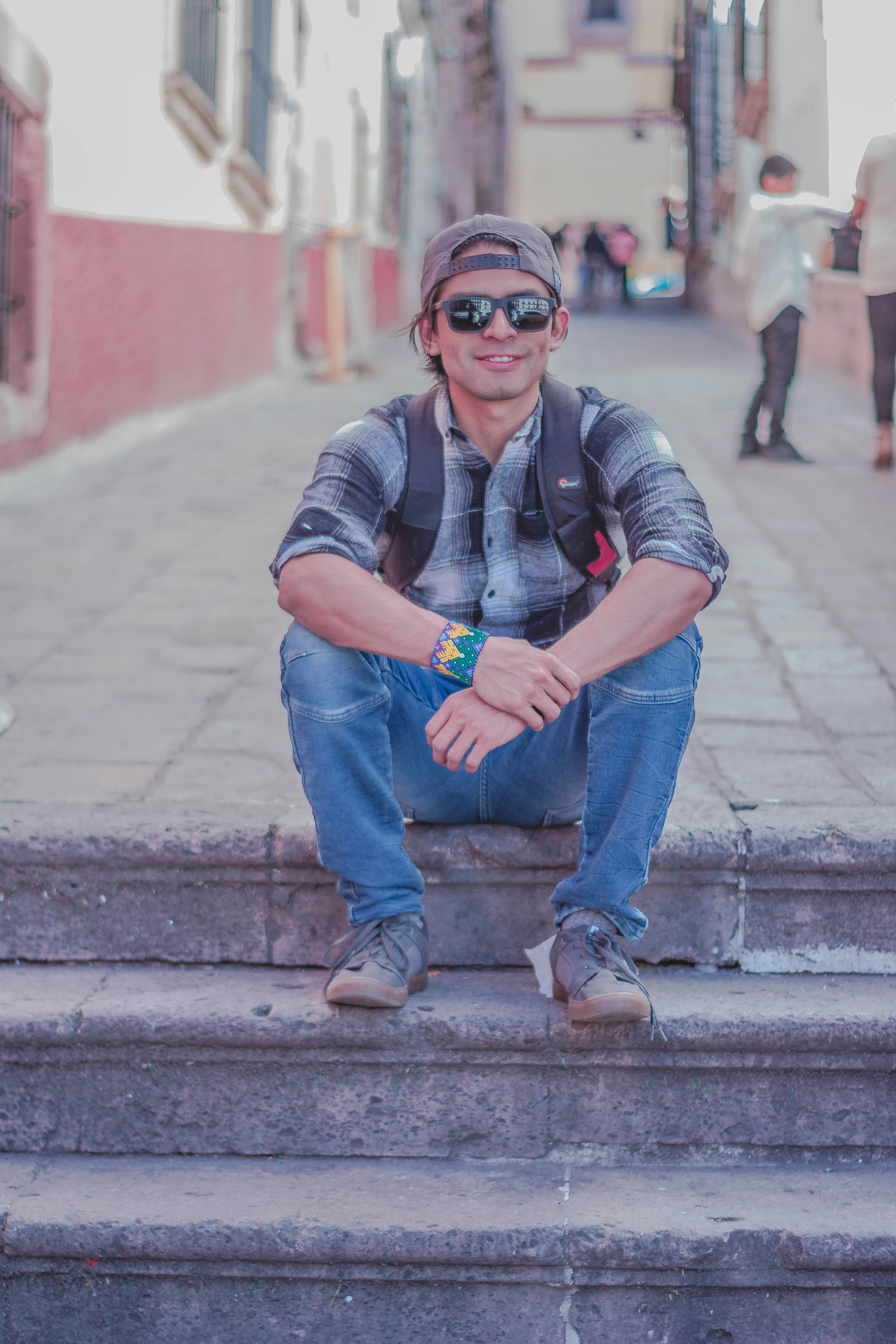 Man in blue denim jeans sitting on concrete stairs photo – Free ...