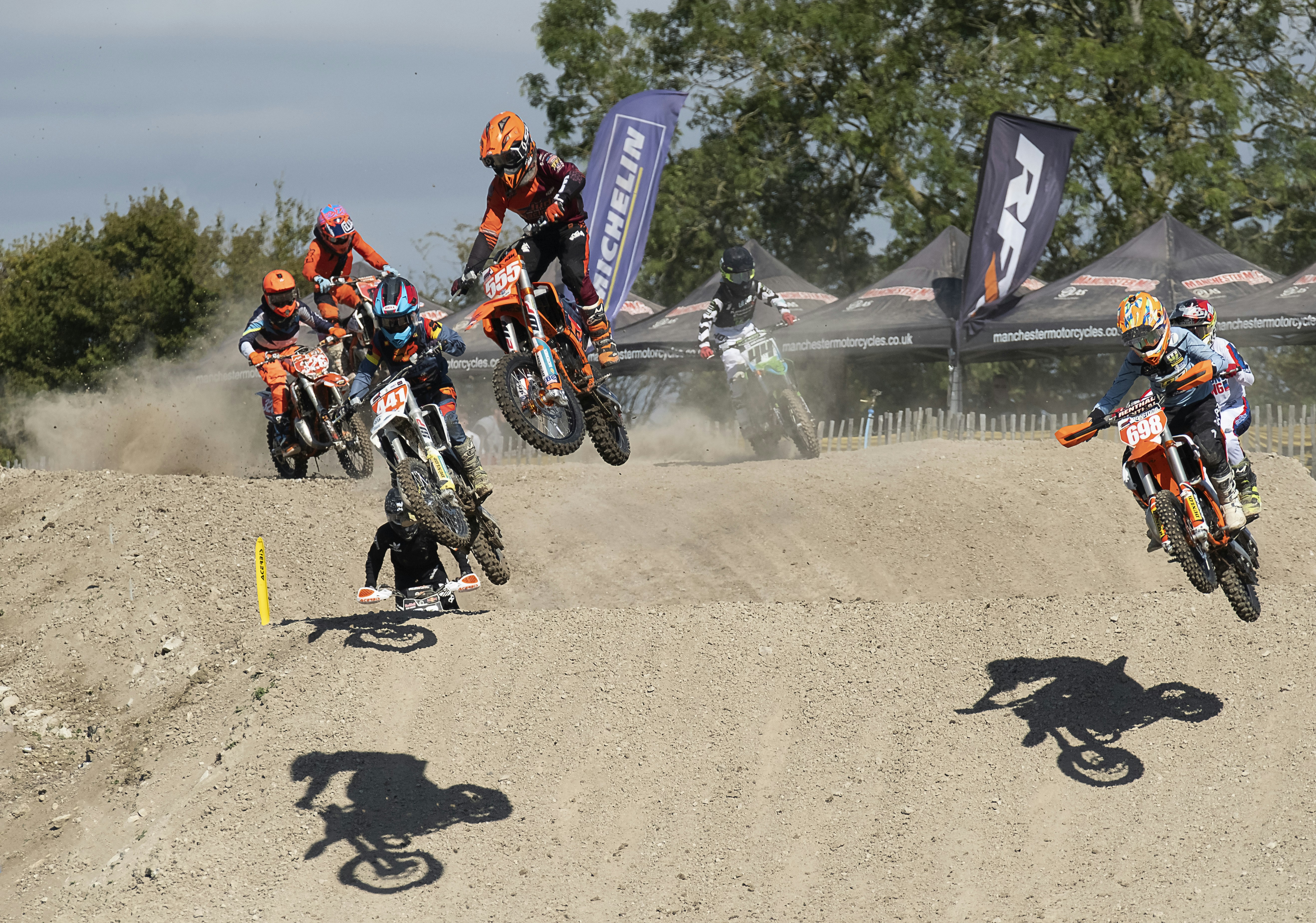 People riding motocross dirt bikes on dirt road during daytime photo ...