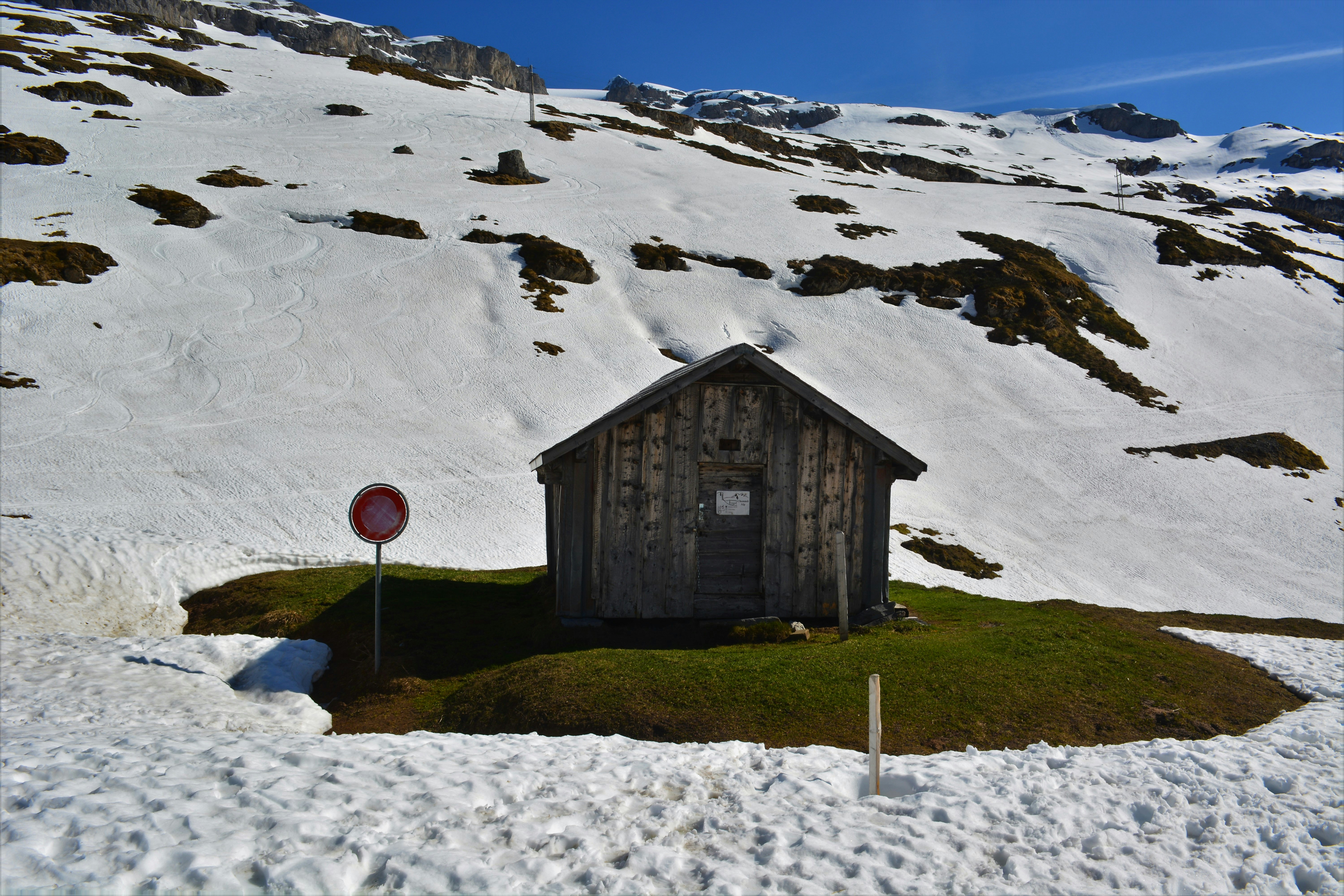 brown wooden house on snow covered ground