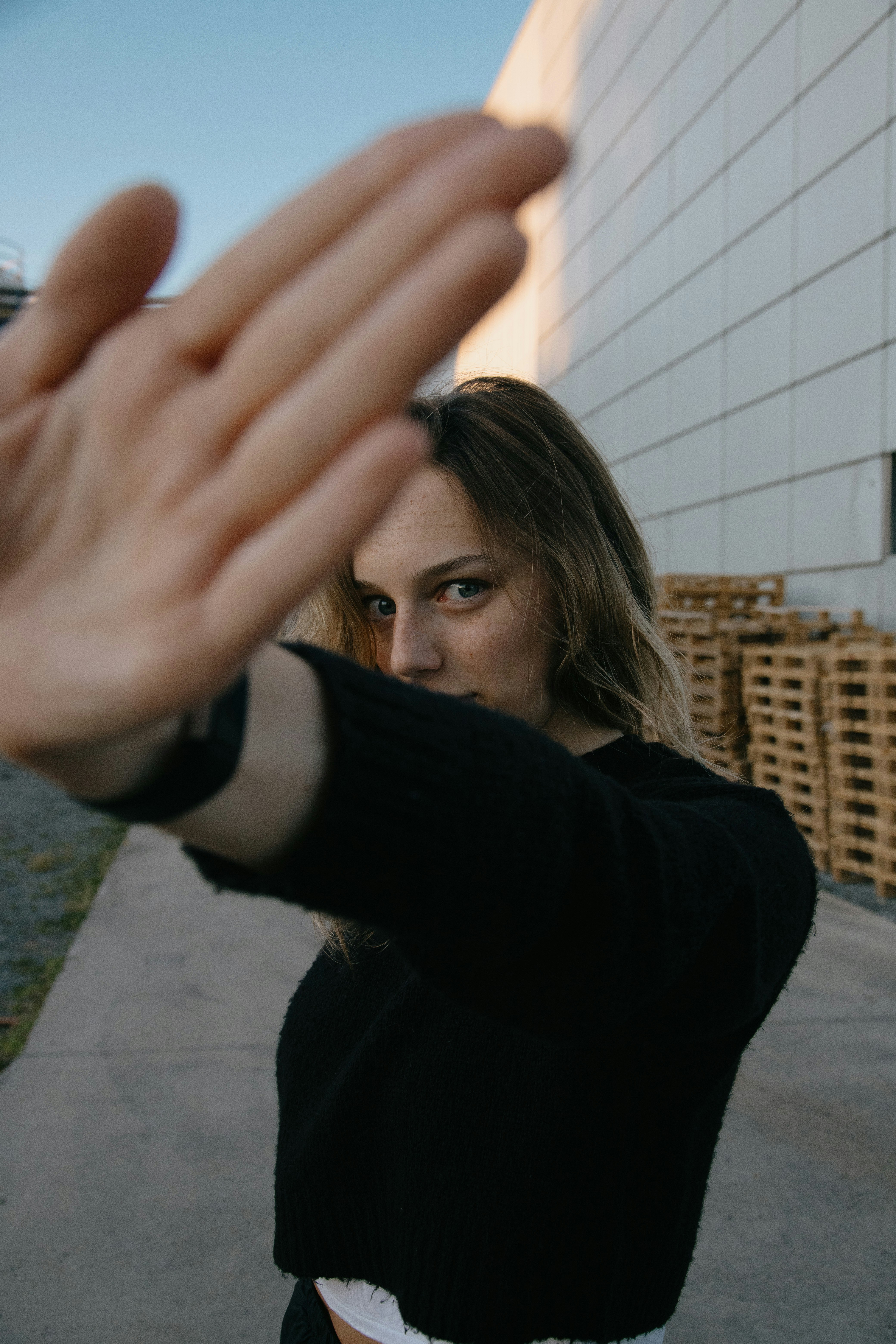 Gaze Through a Barrier: Portrait Framed by an Outstretched Hand