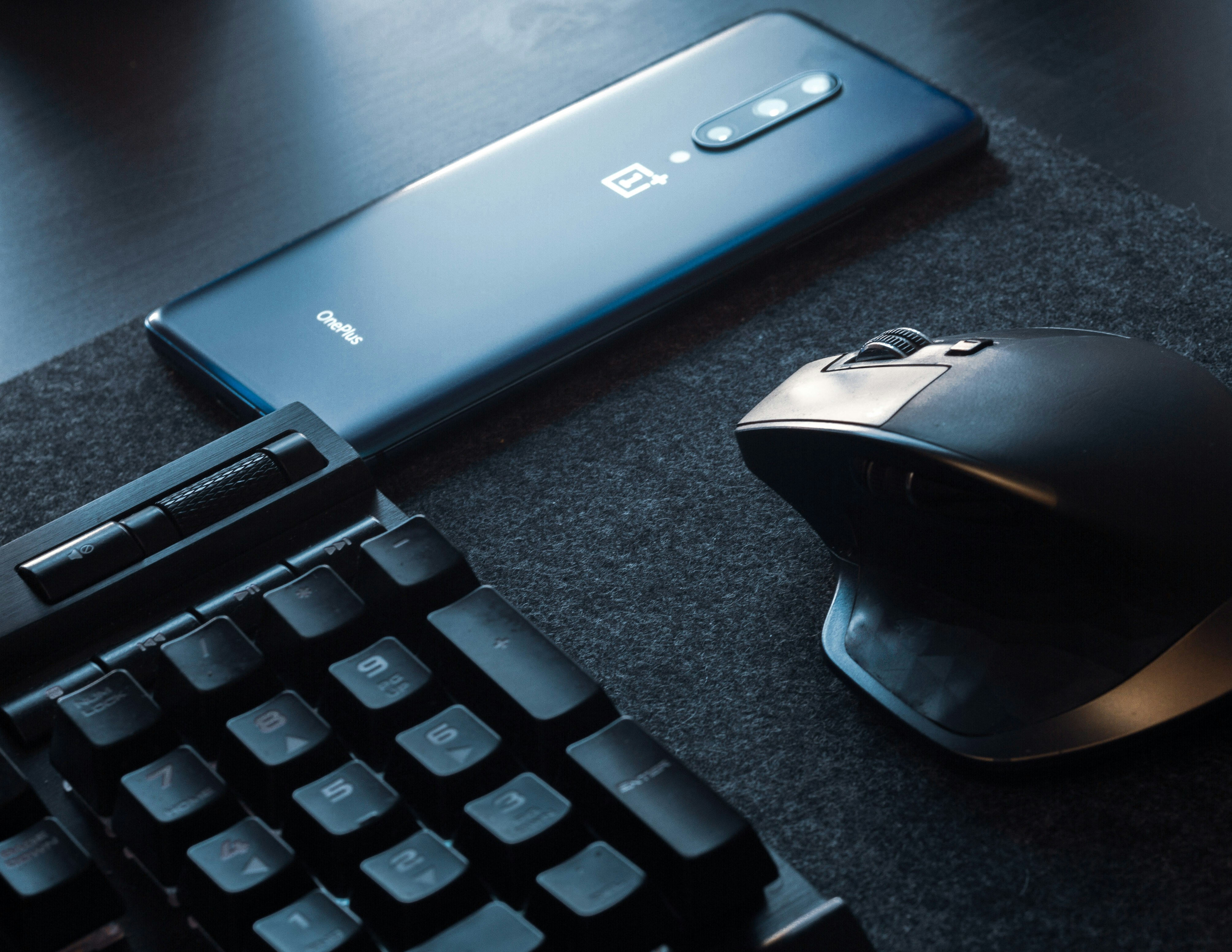 Black and blue logitech cordless computer mouse beside black computer ...