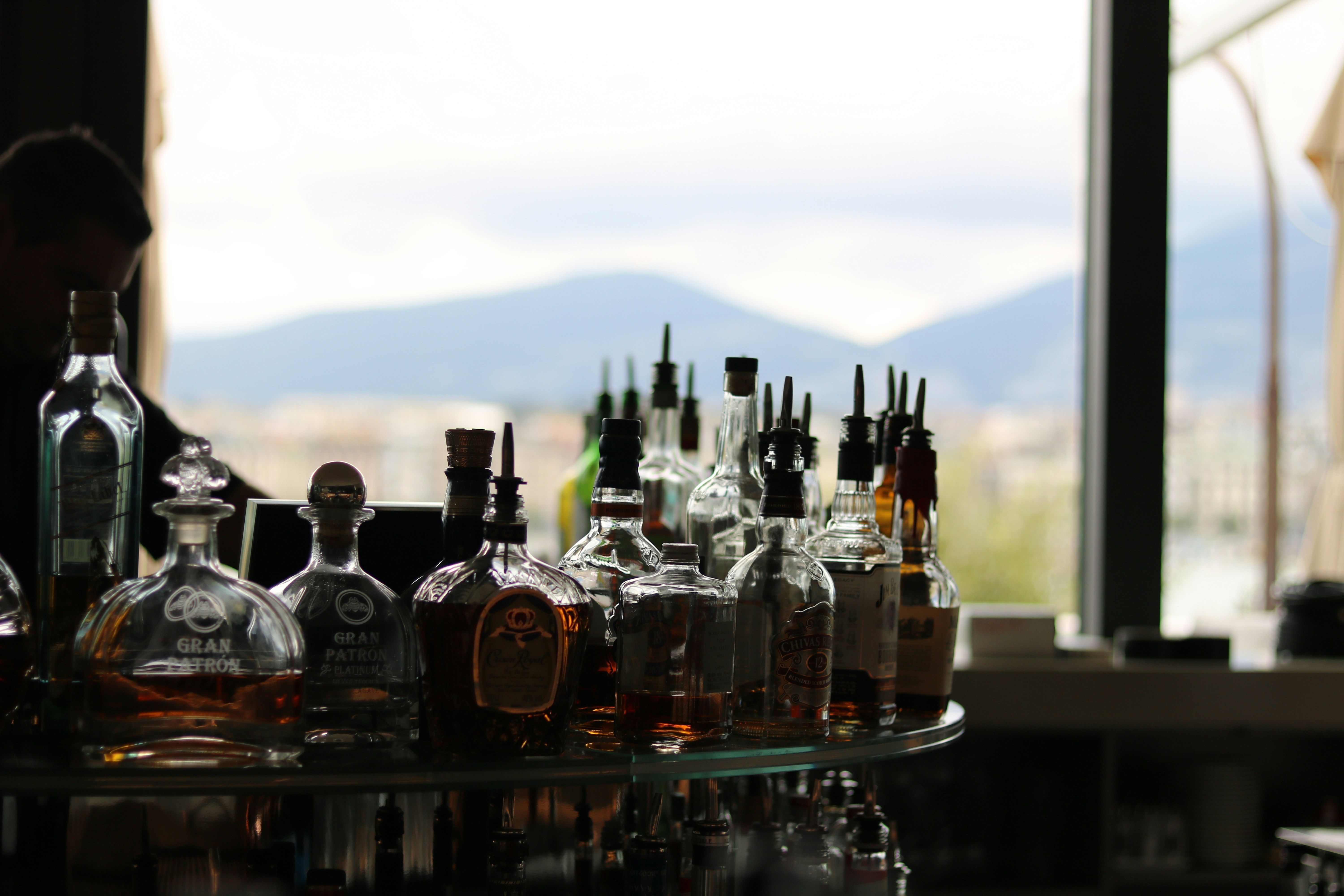 Glass Bar Stacks: A Quiet Spill of Spirits on a Sunset Shelf