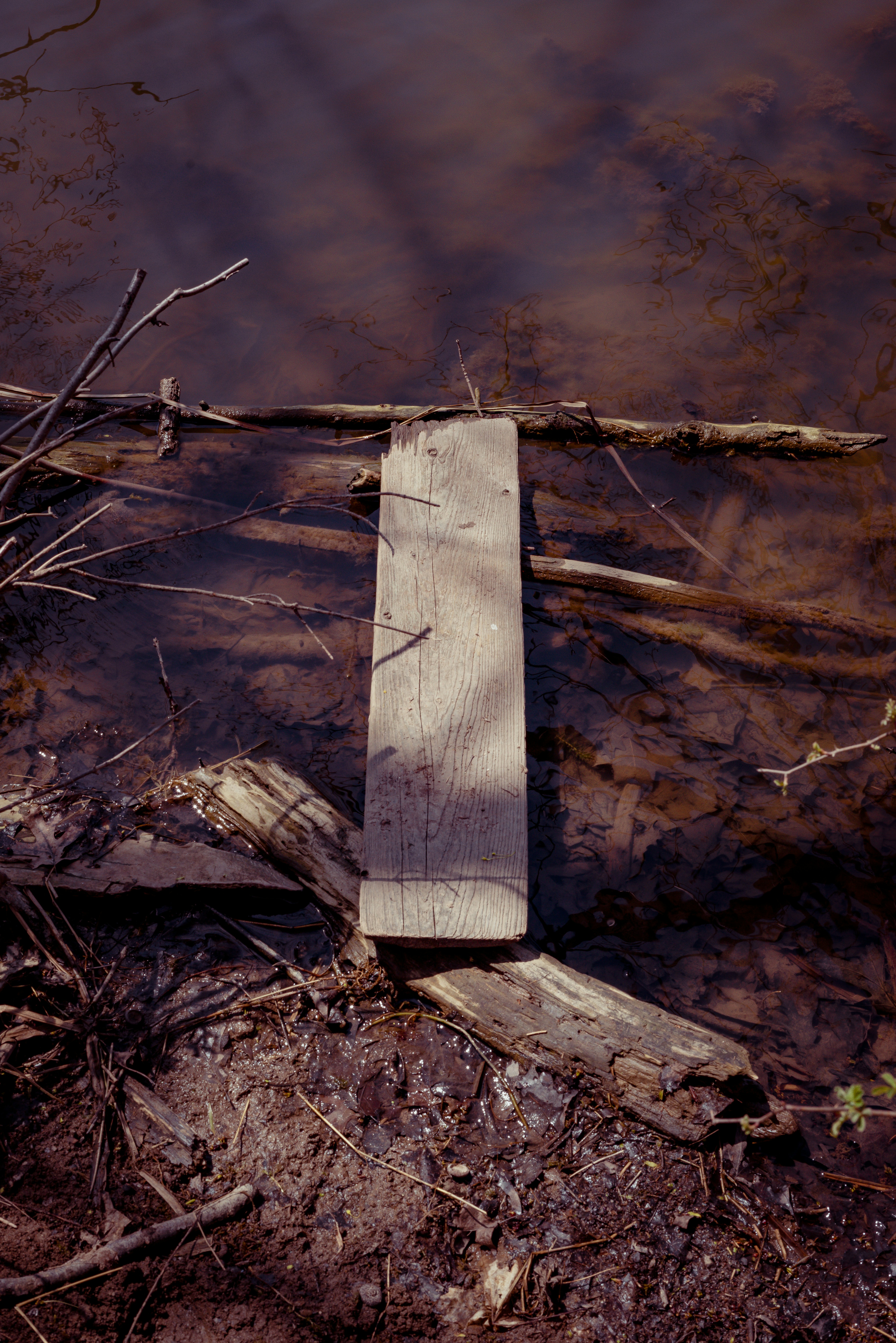 Weathered Pier Strip Resting Over Quiet Brown Water