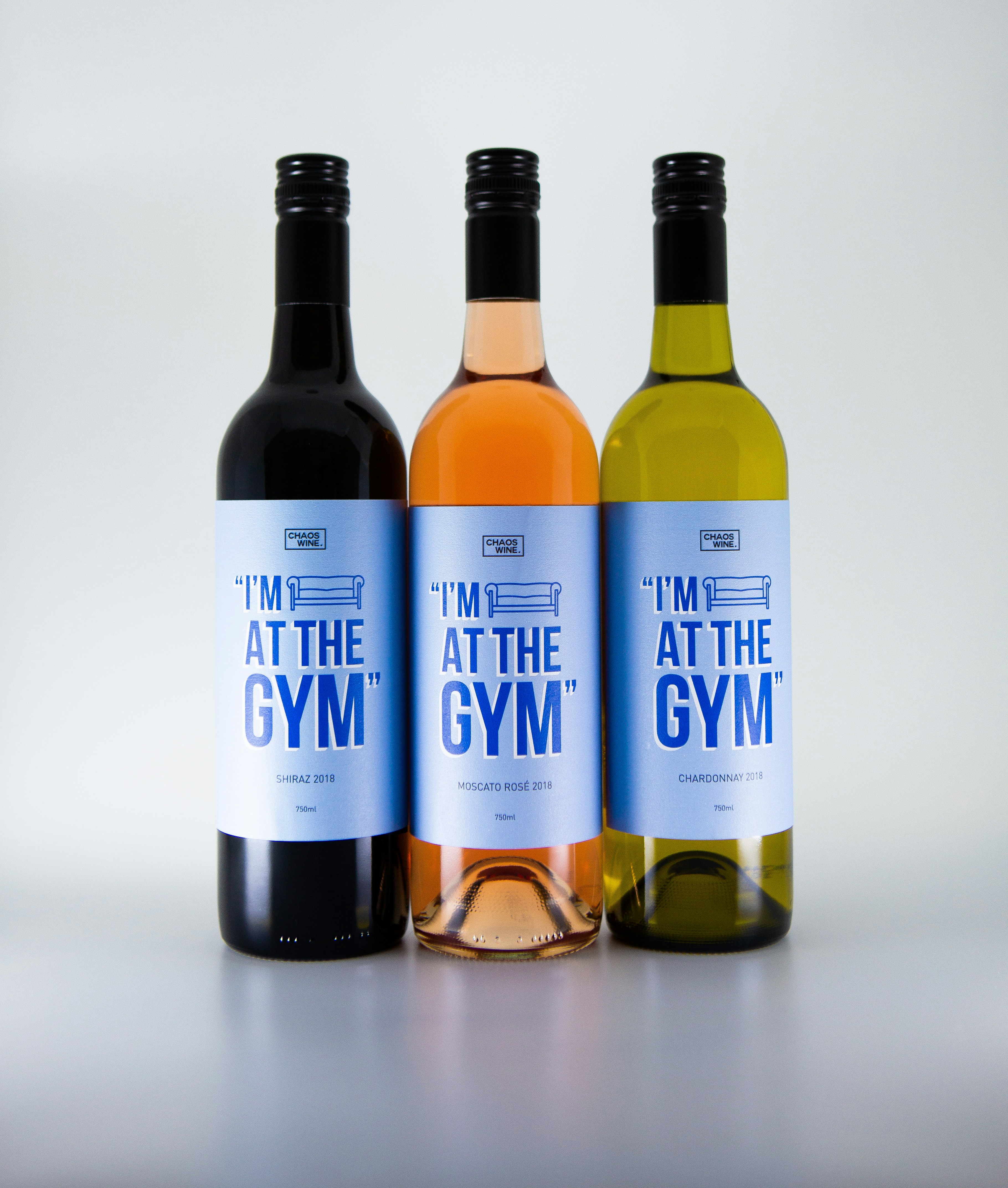 Triple Bottles in Focus: A Minimalist Studio Still with Bold Labels