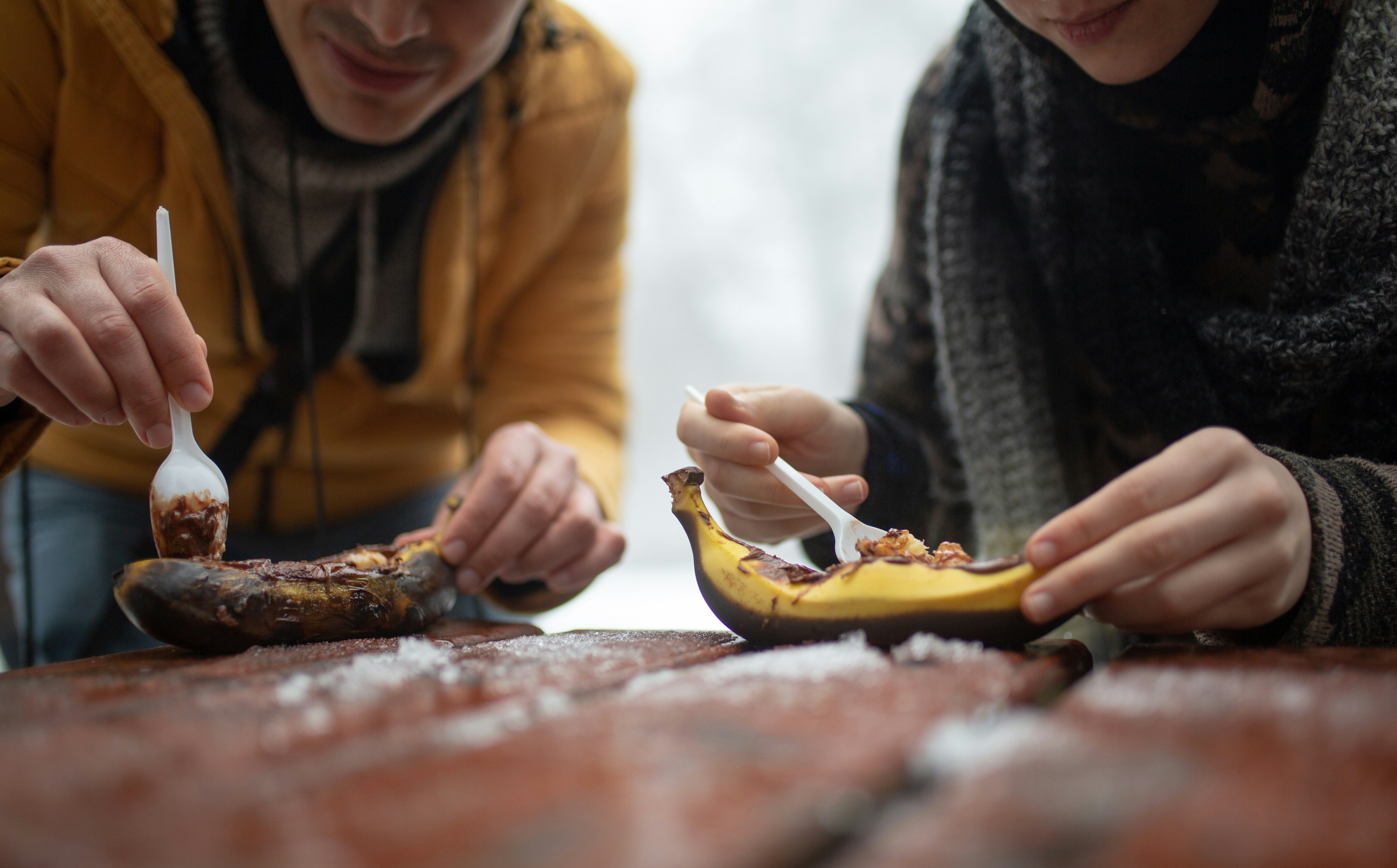 Winter Snack Break: Bananas Shared Over a Frosted Picnic Table