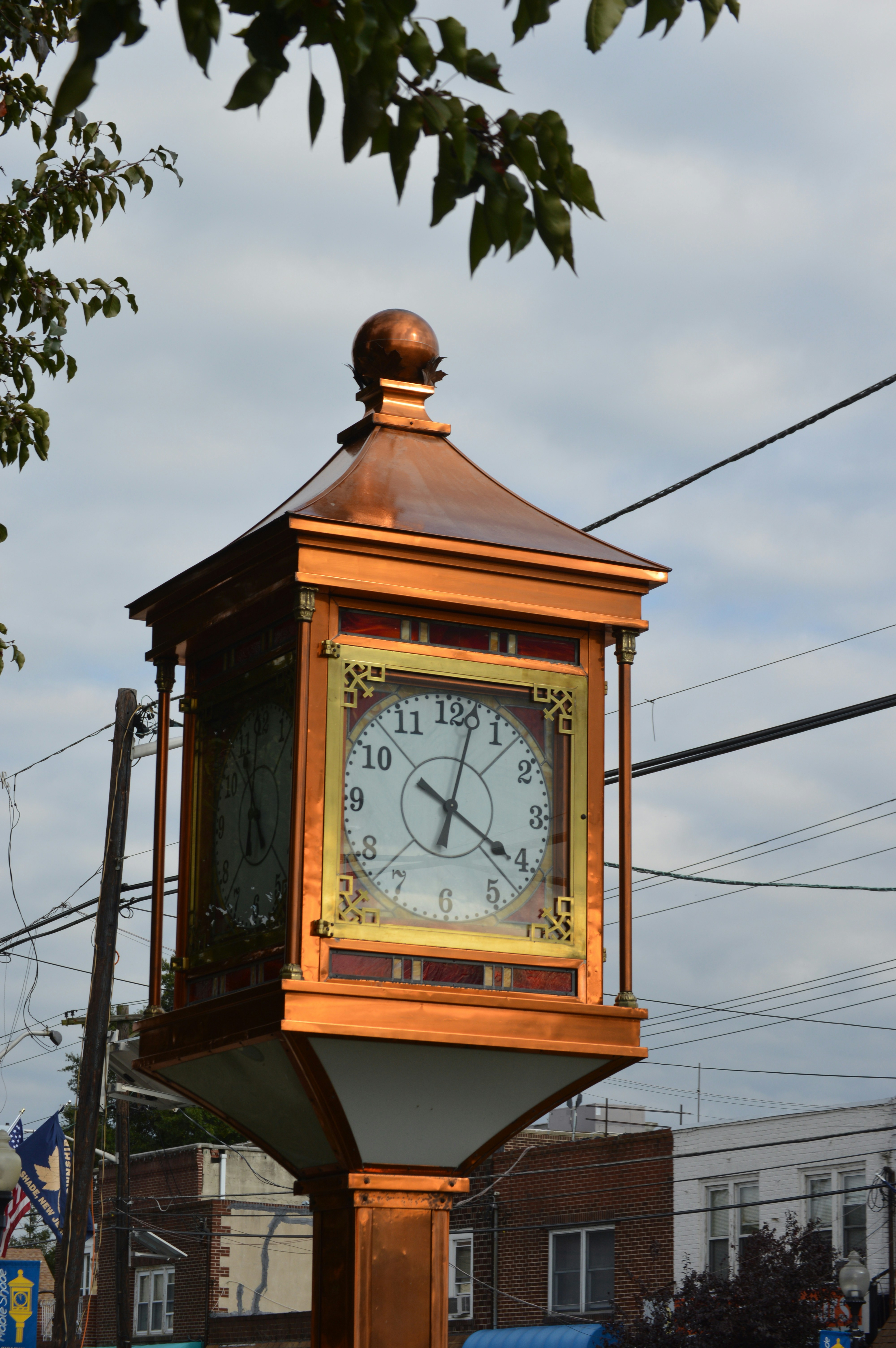 Copper Turret Clock on a Sunlit Main Street