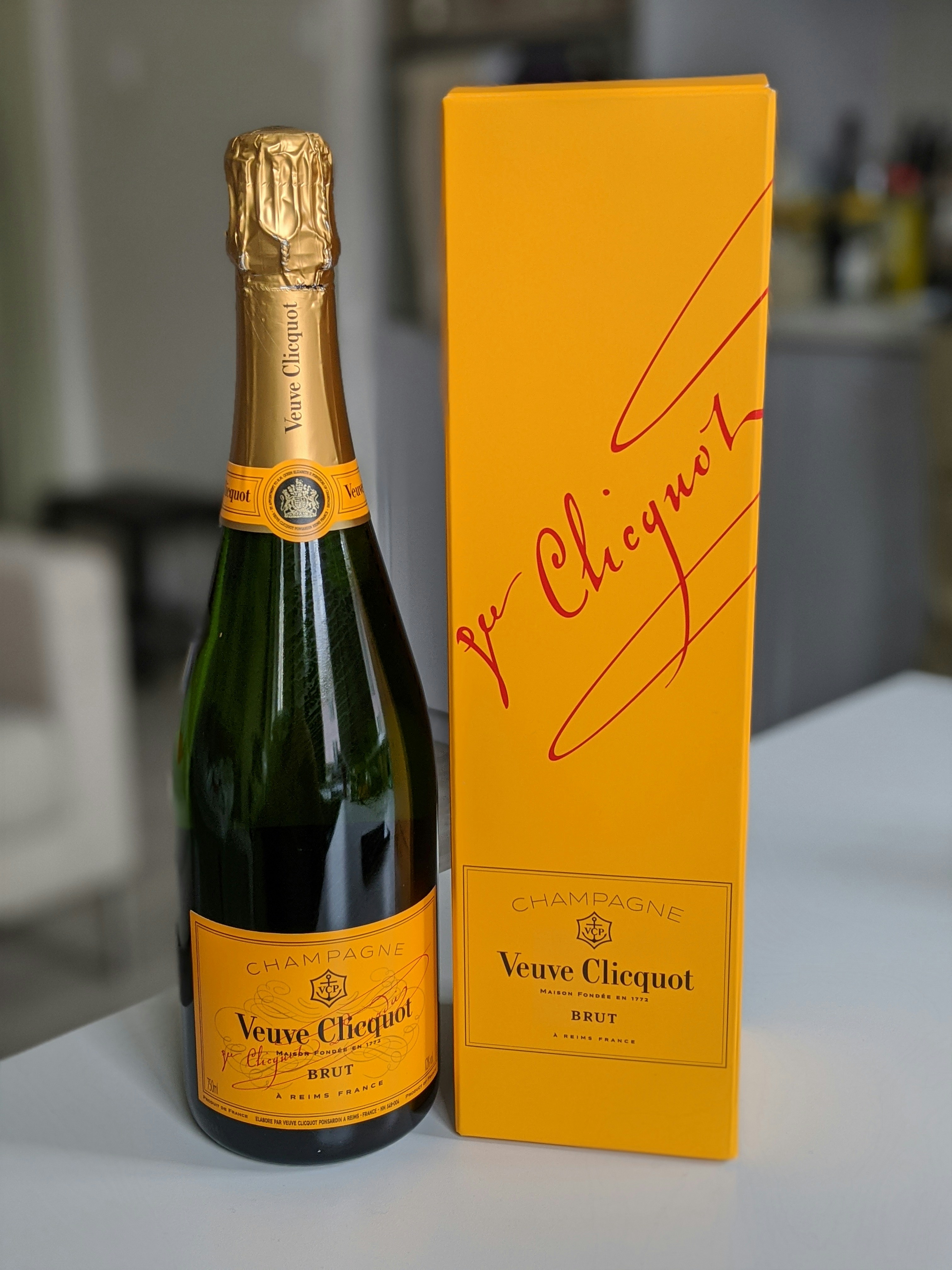 Veuve Clicquot Duet: A Champagne Bottle Framed by its Vibrant Orange Box