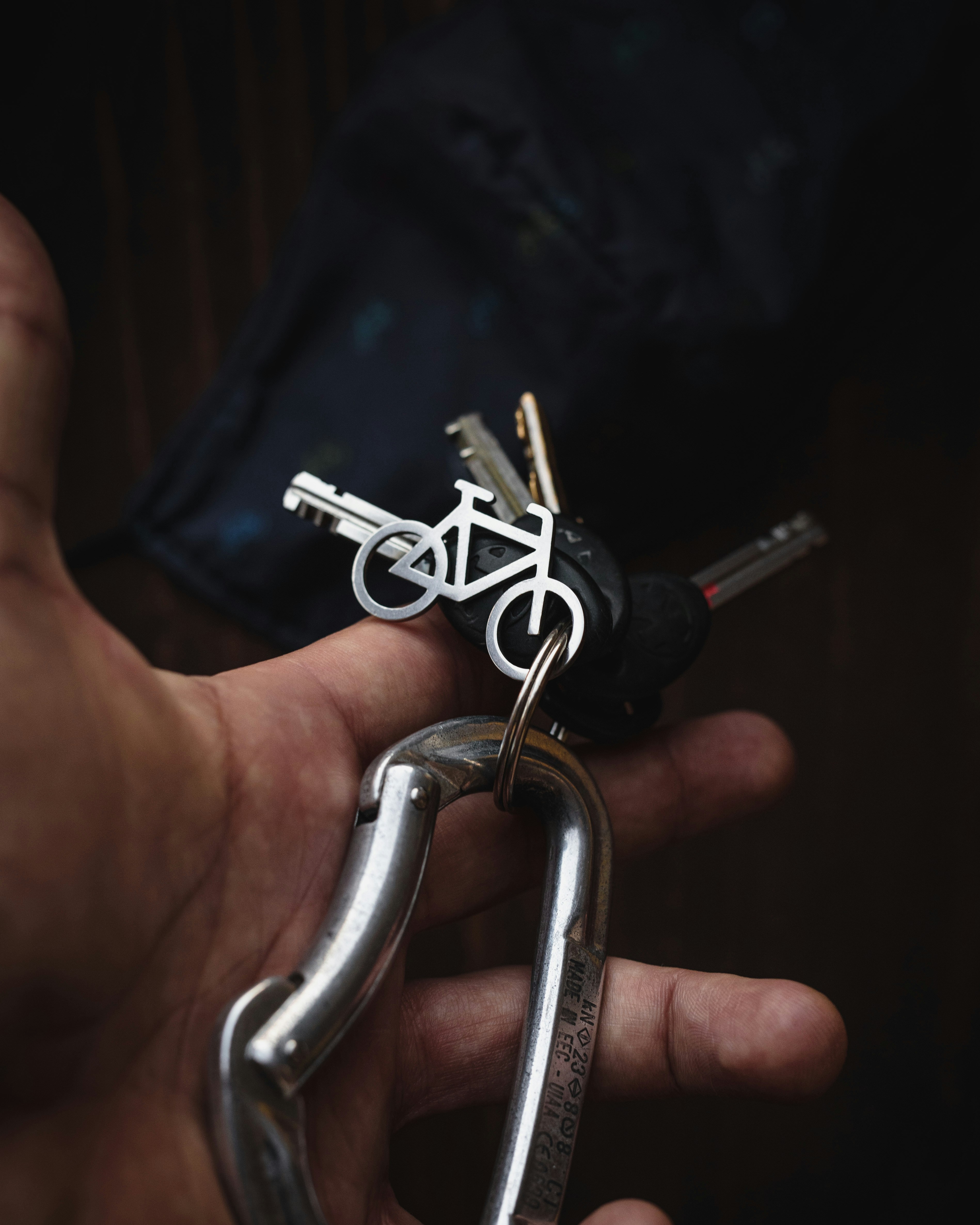 Tiny Bicycle Keychain Resting on a Gleaming Carabiner