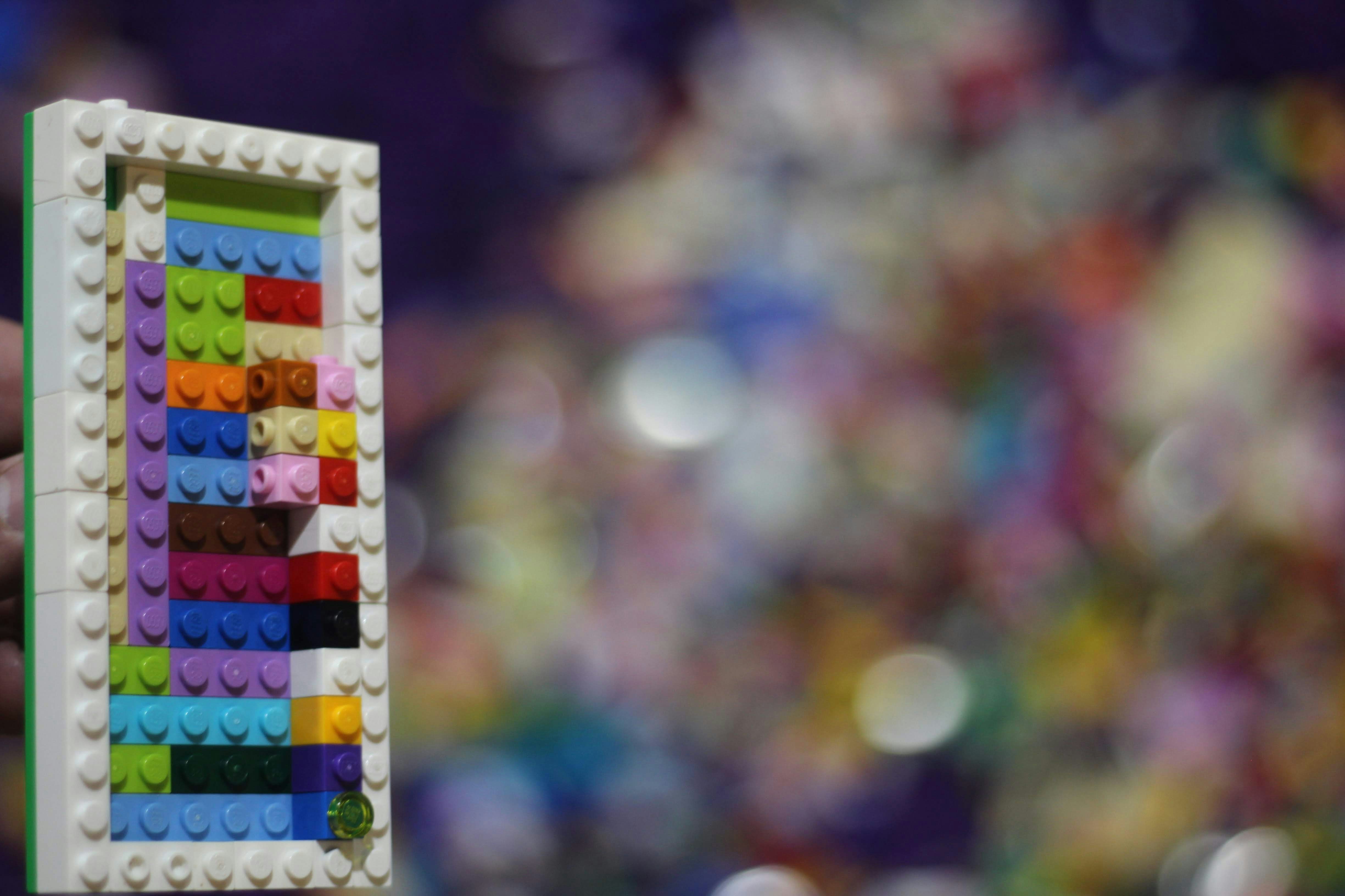 Rainbow brick mosaic framed in white, standing out against a kaleidoscopic blur