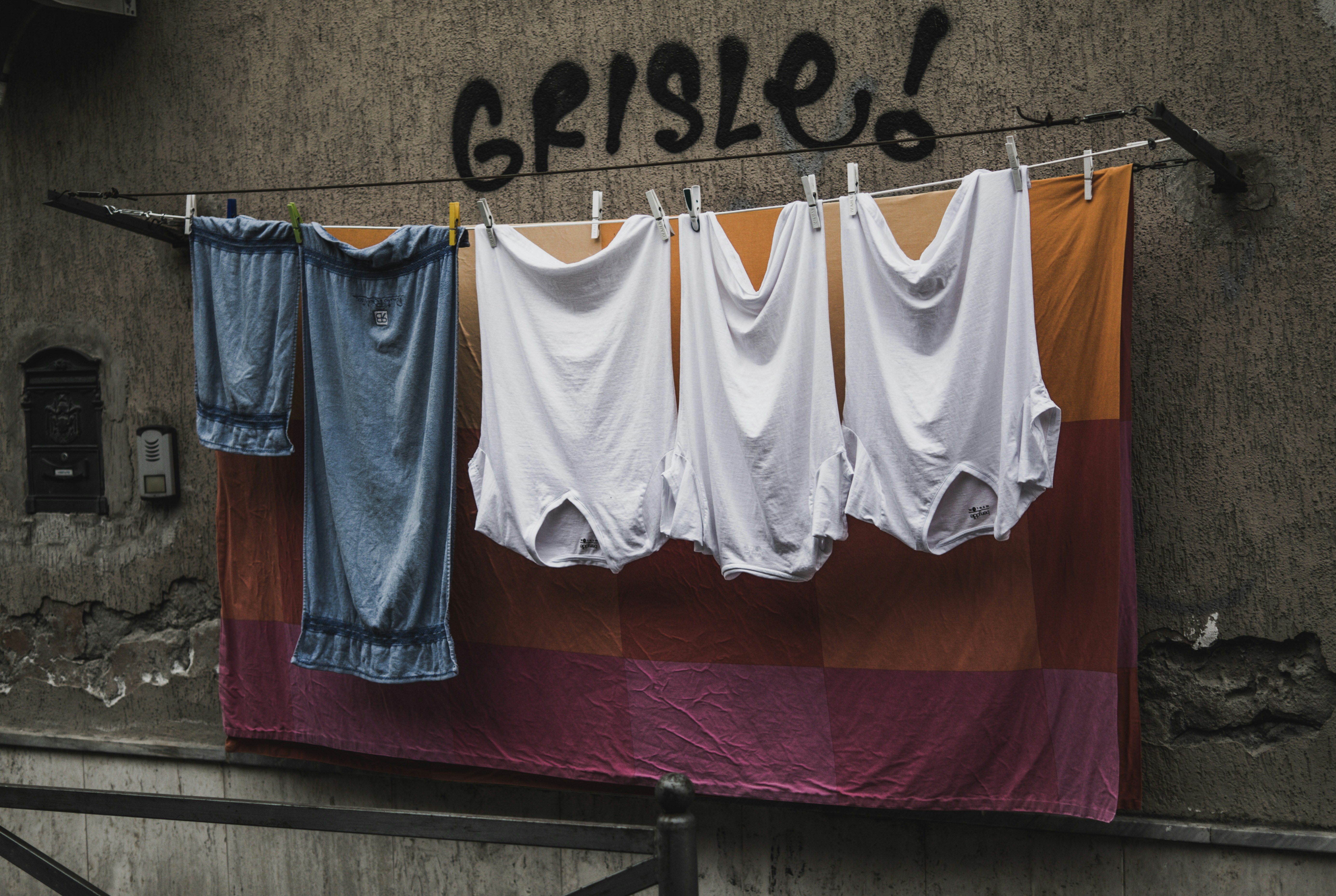 Laundry on the Line: Colors Cling to a Quiet Wall
