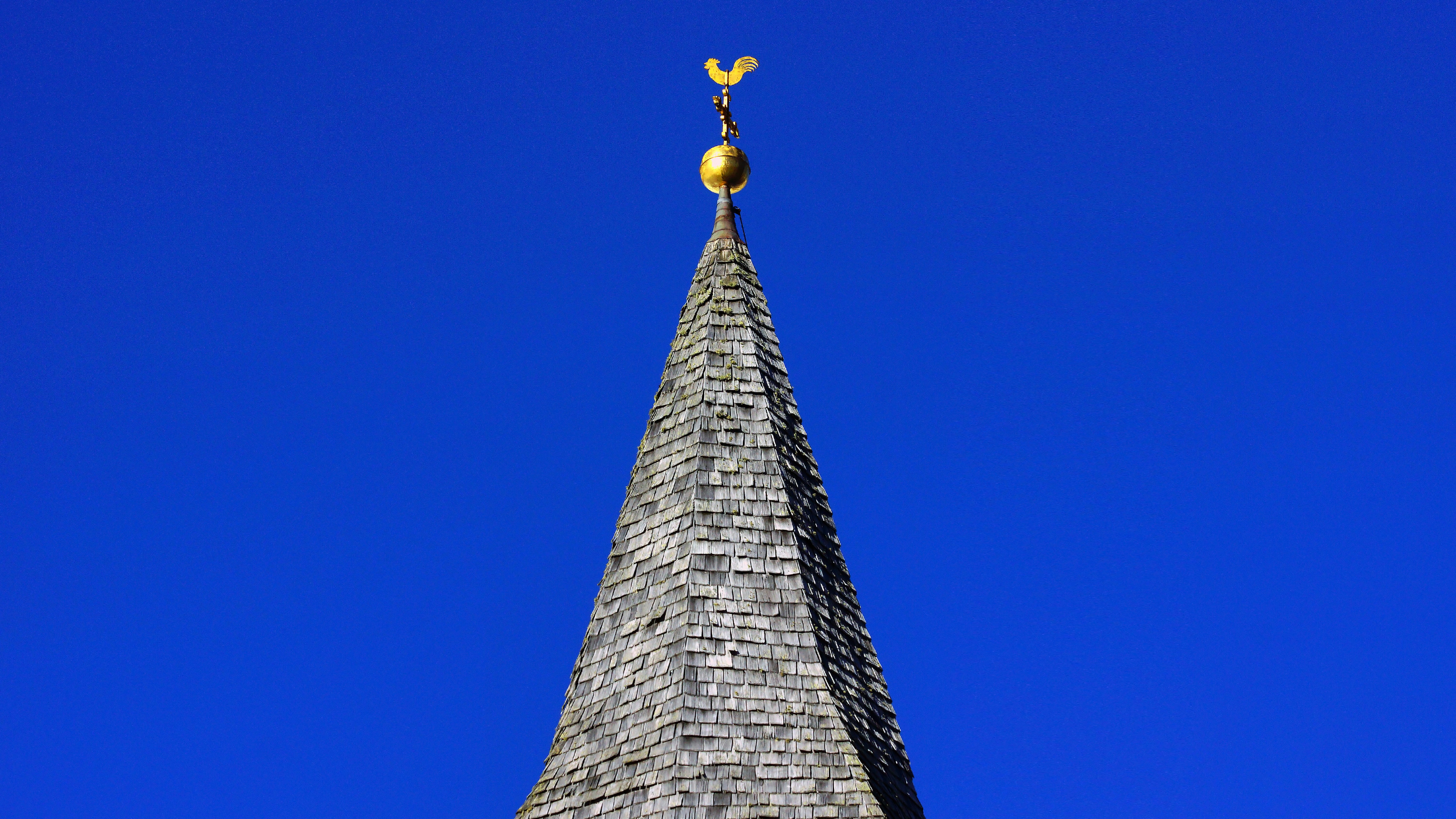 Summit Crest: A weathered steeple against a velvet blue sky