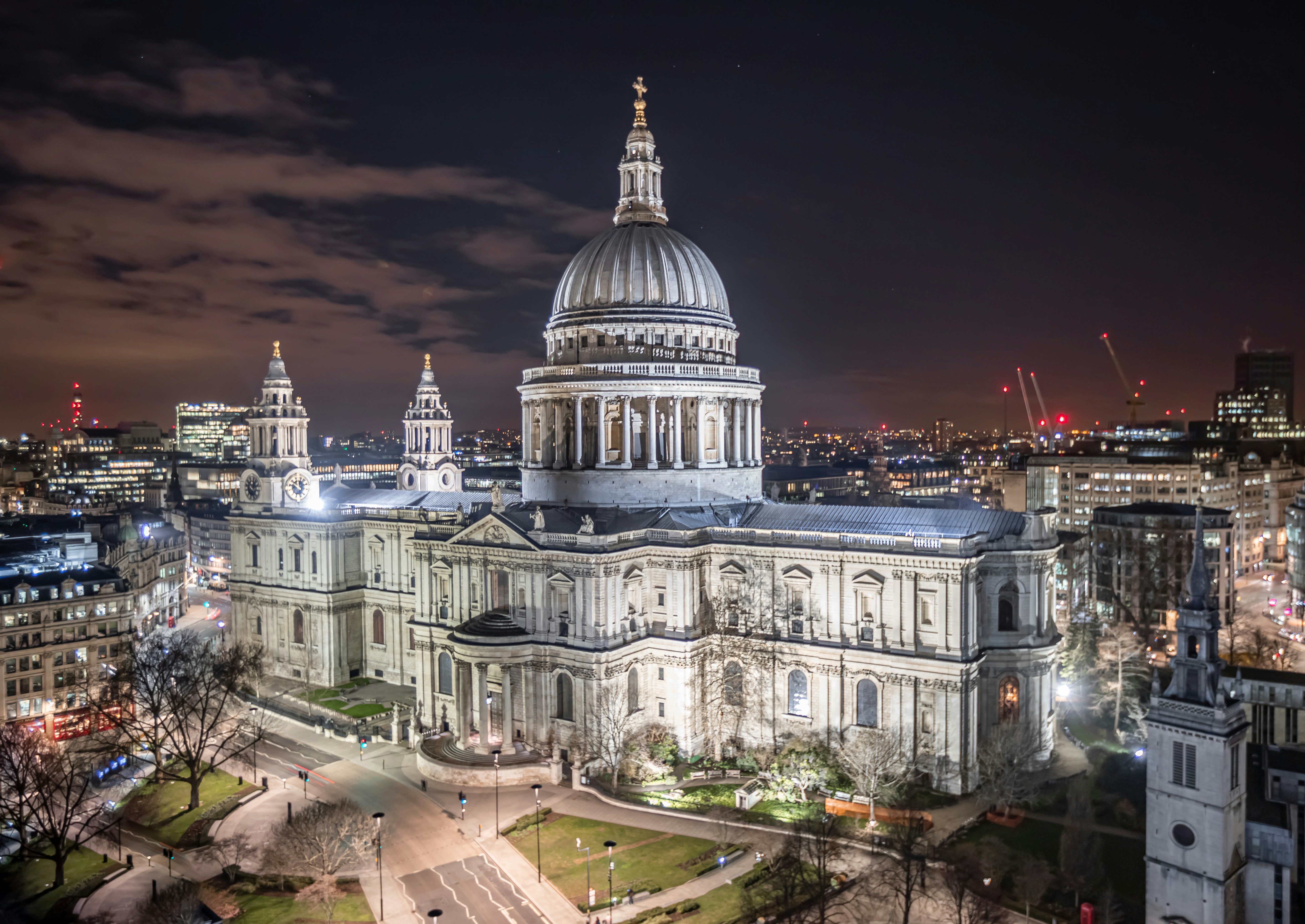 St. Paul's Cathedral illuminated against a night sky, showcasing its architectural beauty and surrounding cityscape.