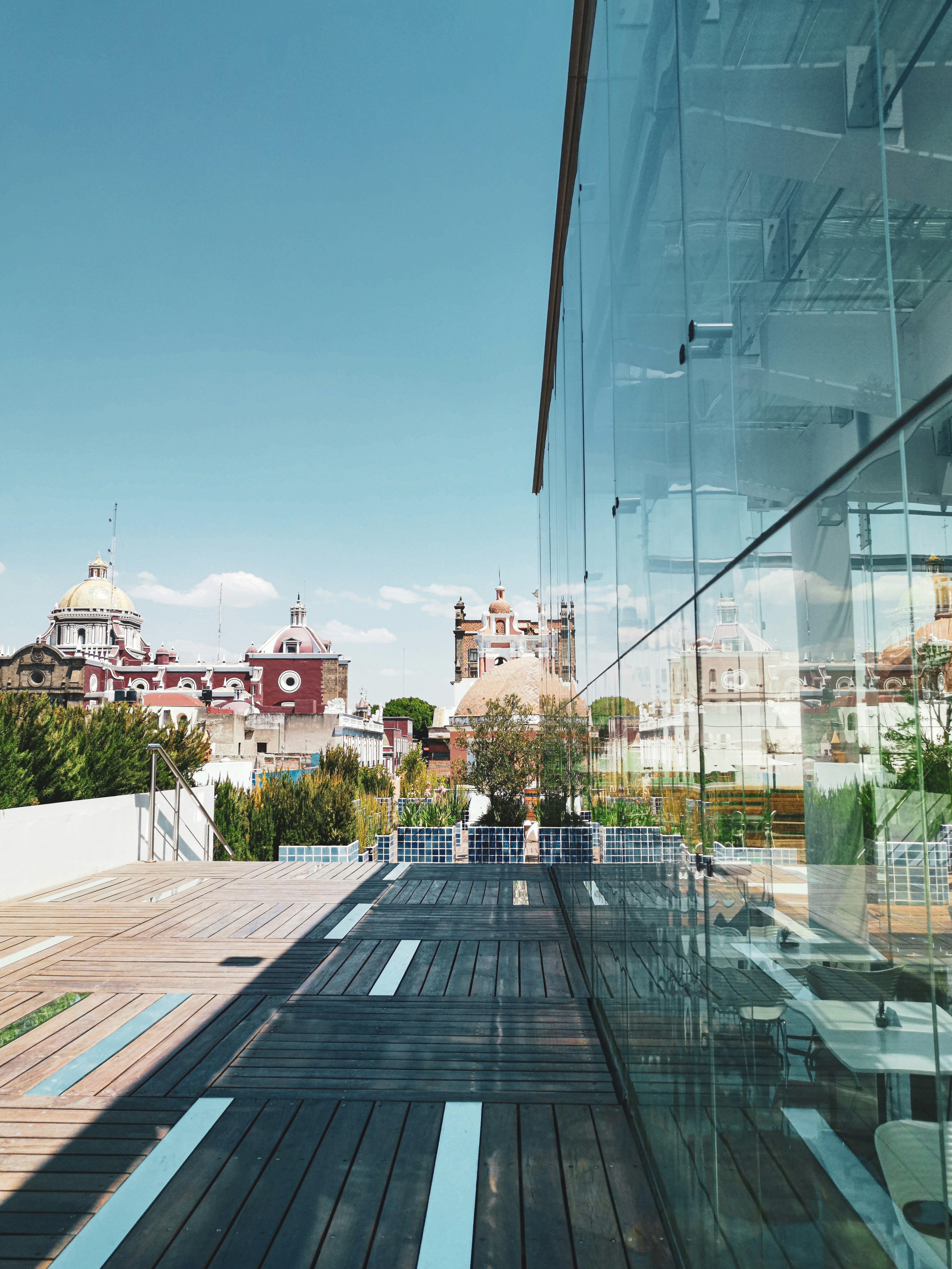 Reflections on a Glass Corridor: Promenade Framing a European City Skyline