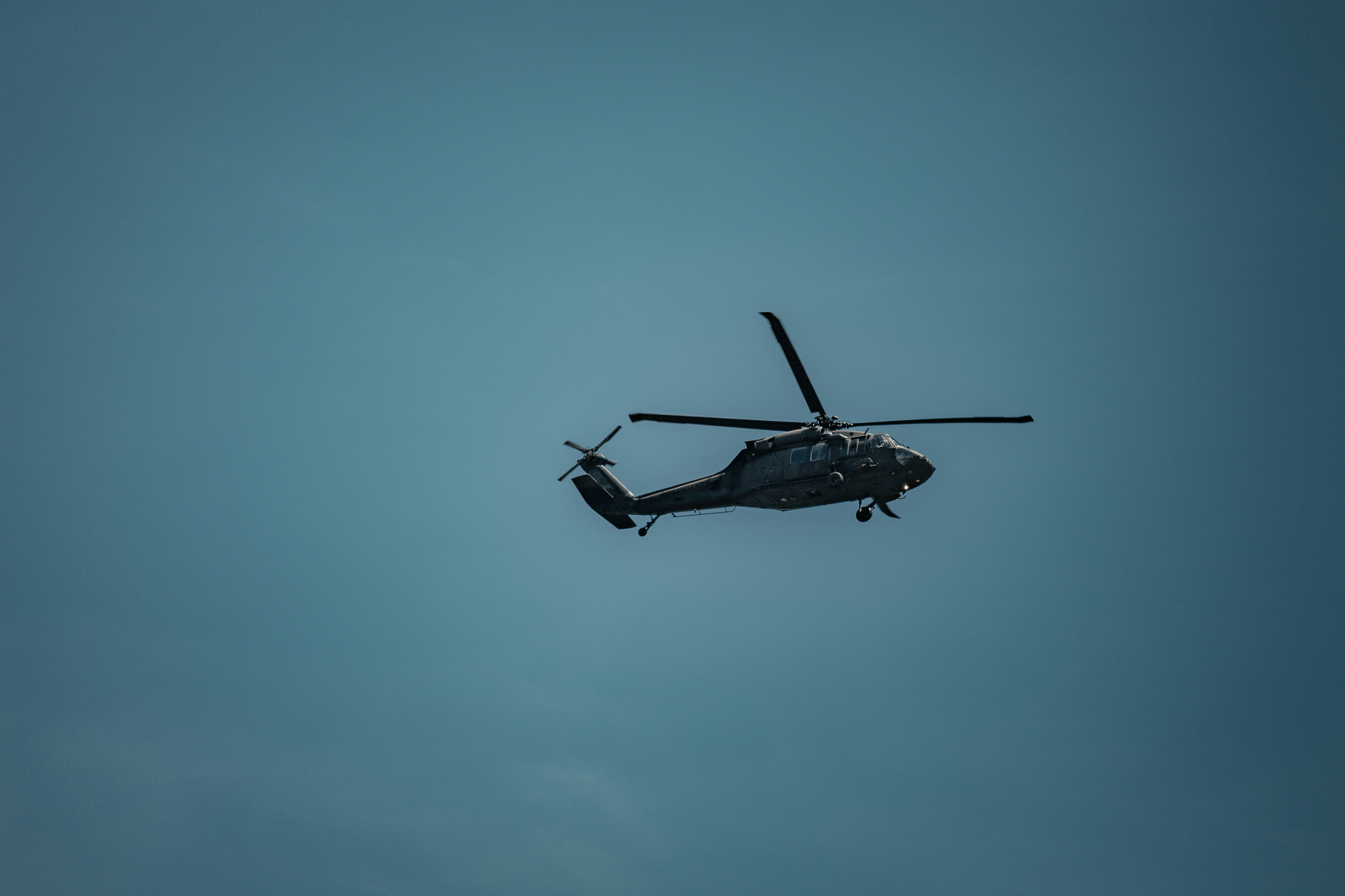Hovering Through Quiet Skies: A Helicopter in Blue