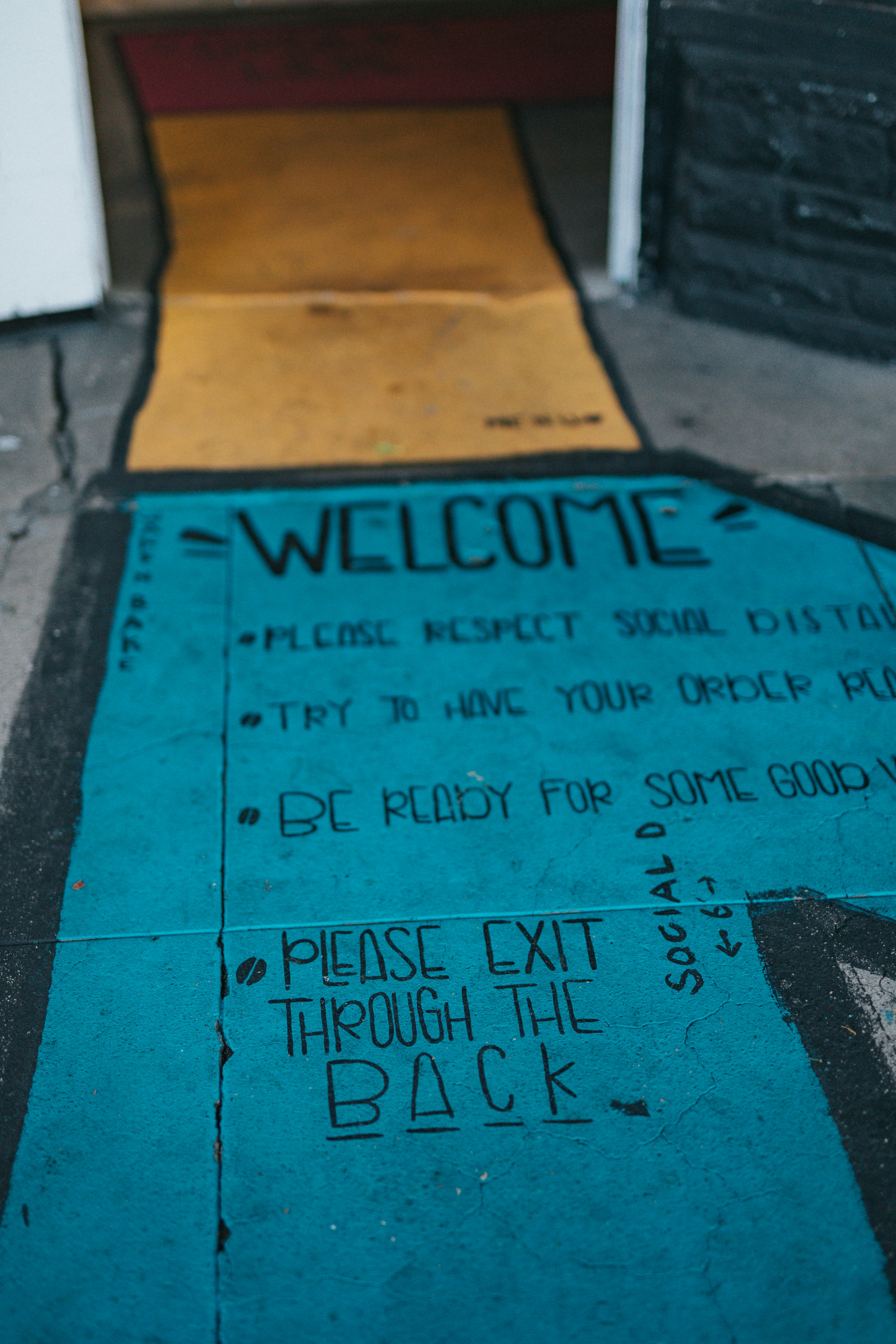 Blue Threshold of Welcome: Handwritten Guidance Across a Painted Sidewalk