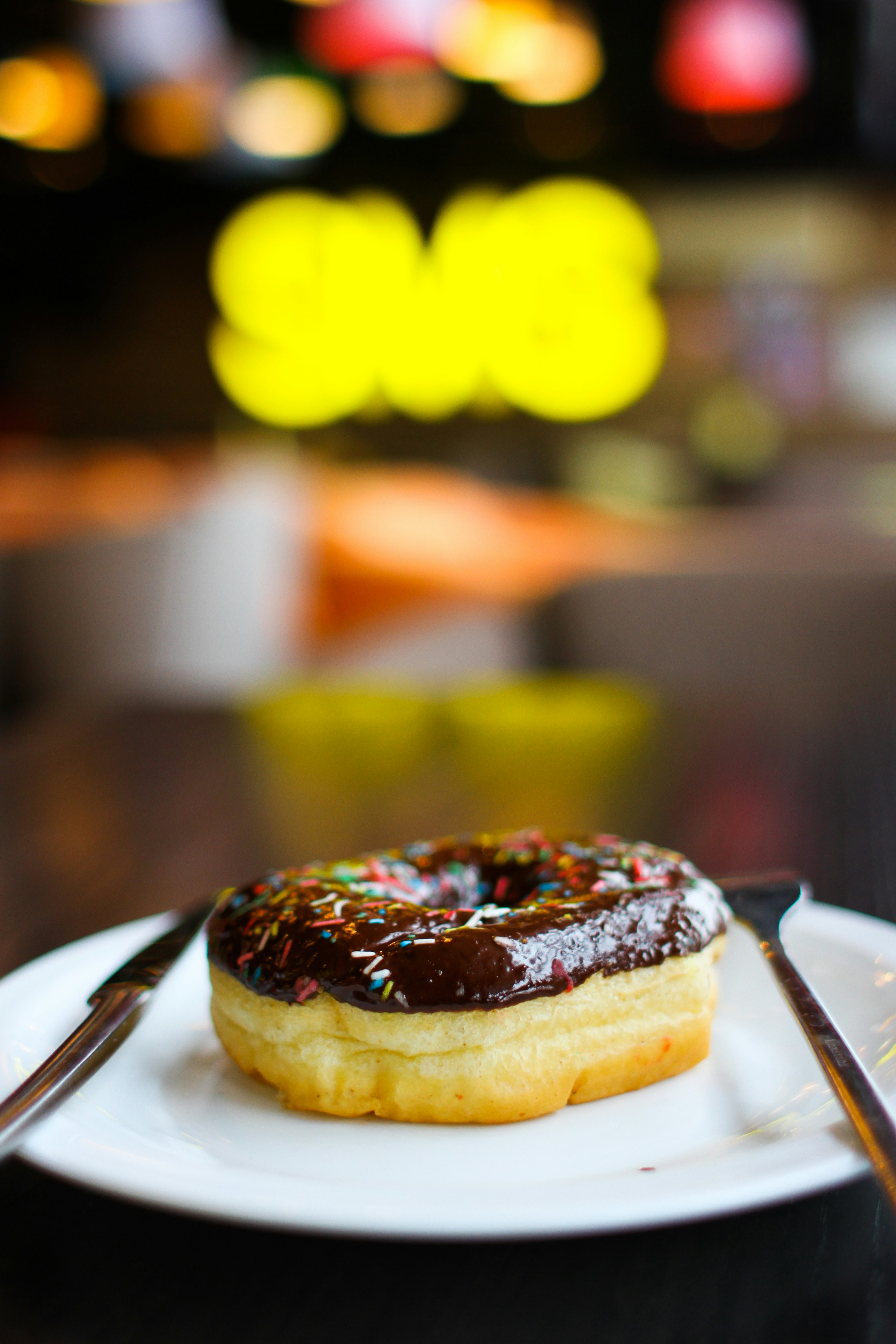 A Glazed Donut on a Quiet Table at Dusk Café