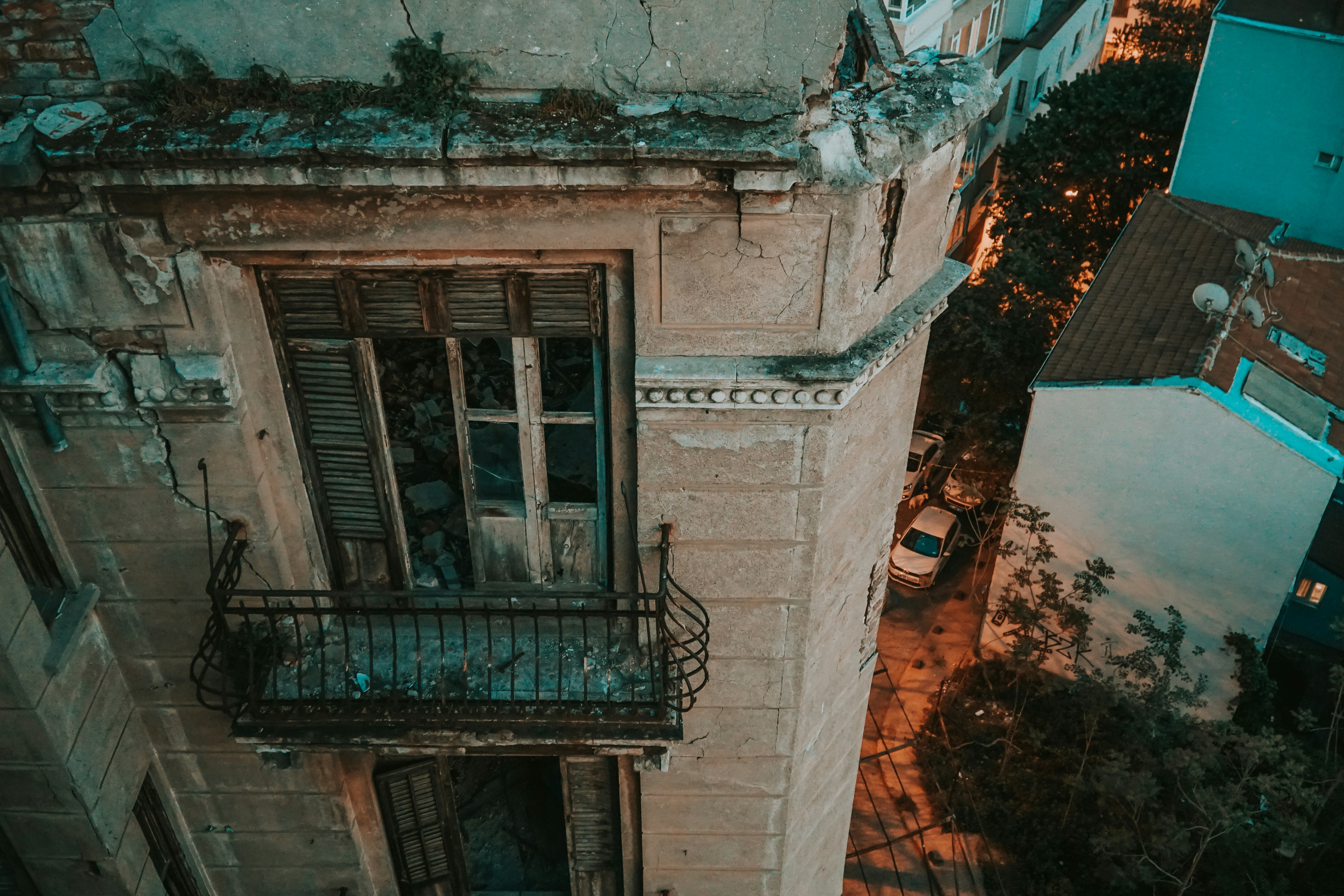 Aerial Quiet: A Windowed Corner of Old Architecture Overlooking a Narrow Street