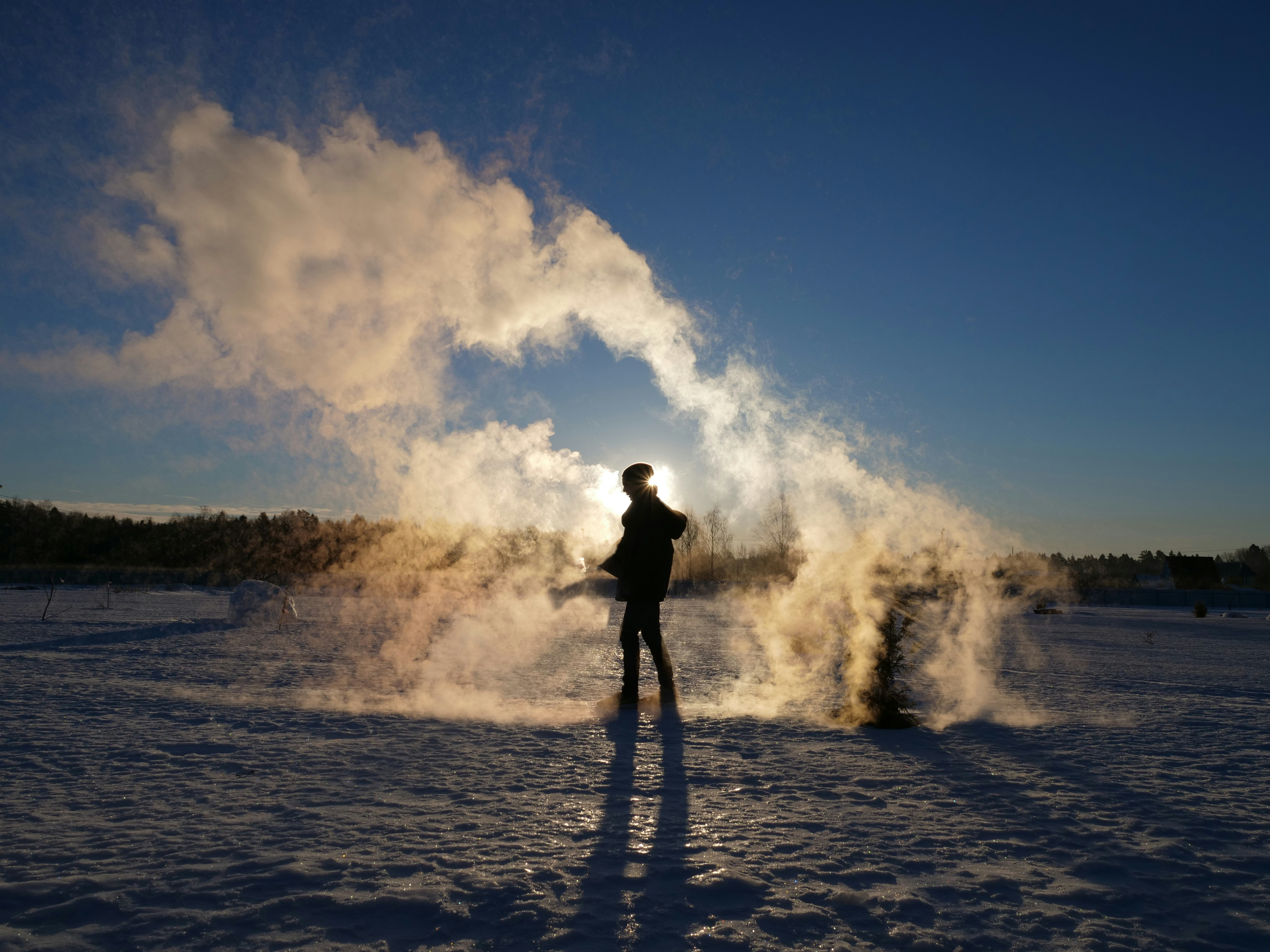 Breath of Steam: A solitary figure in backlit snow
