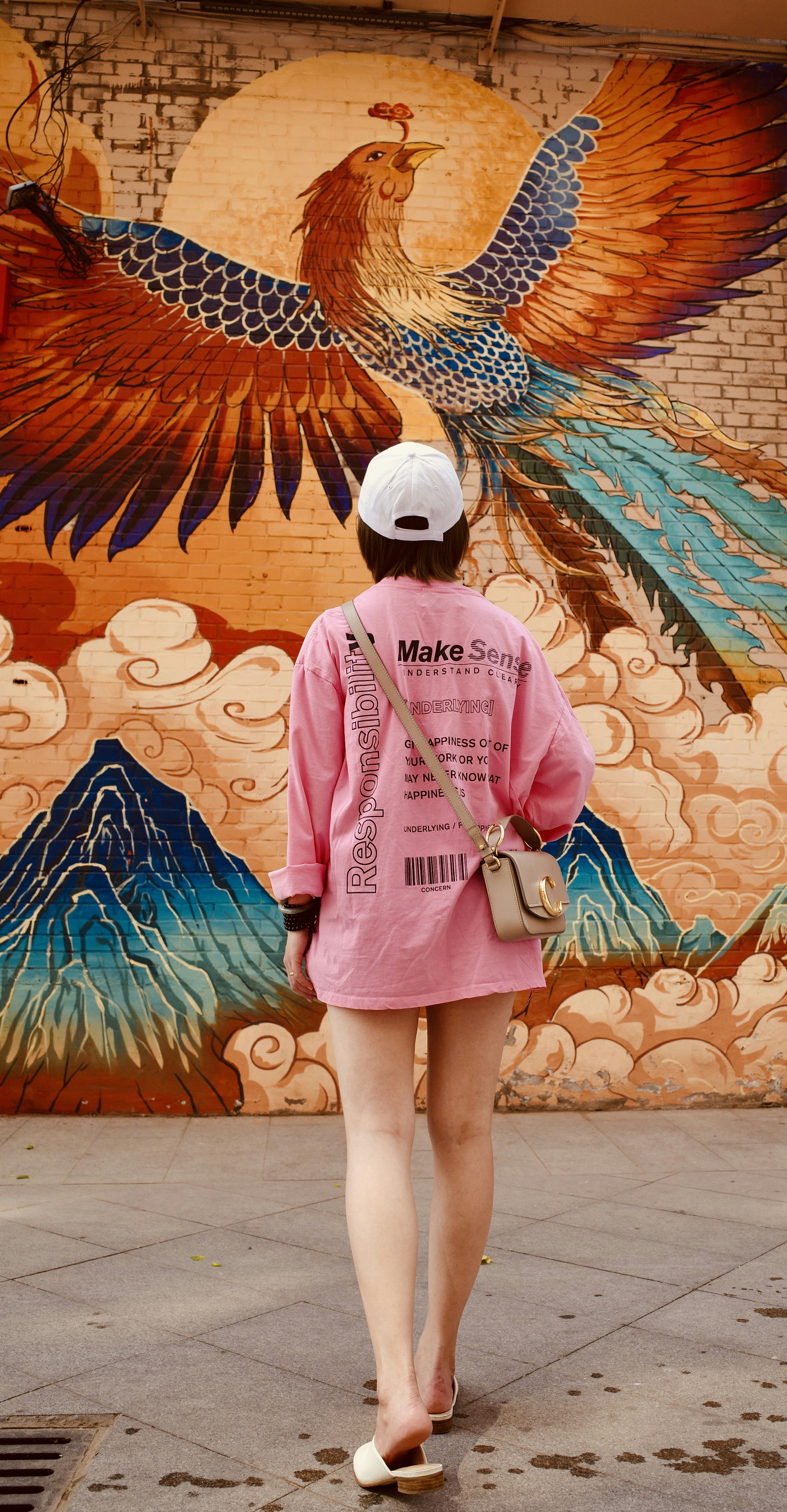 Pink Hoodie, Bold Wings: A Portrait Before the Murals