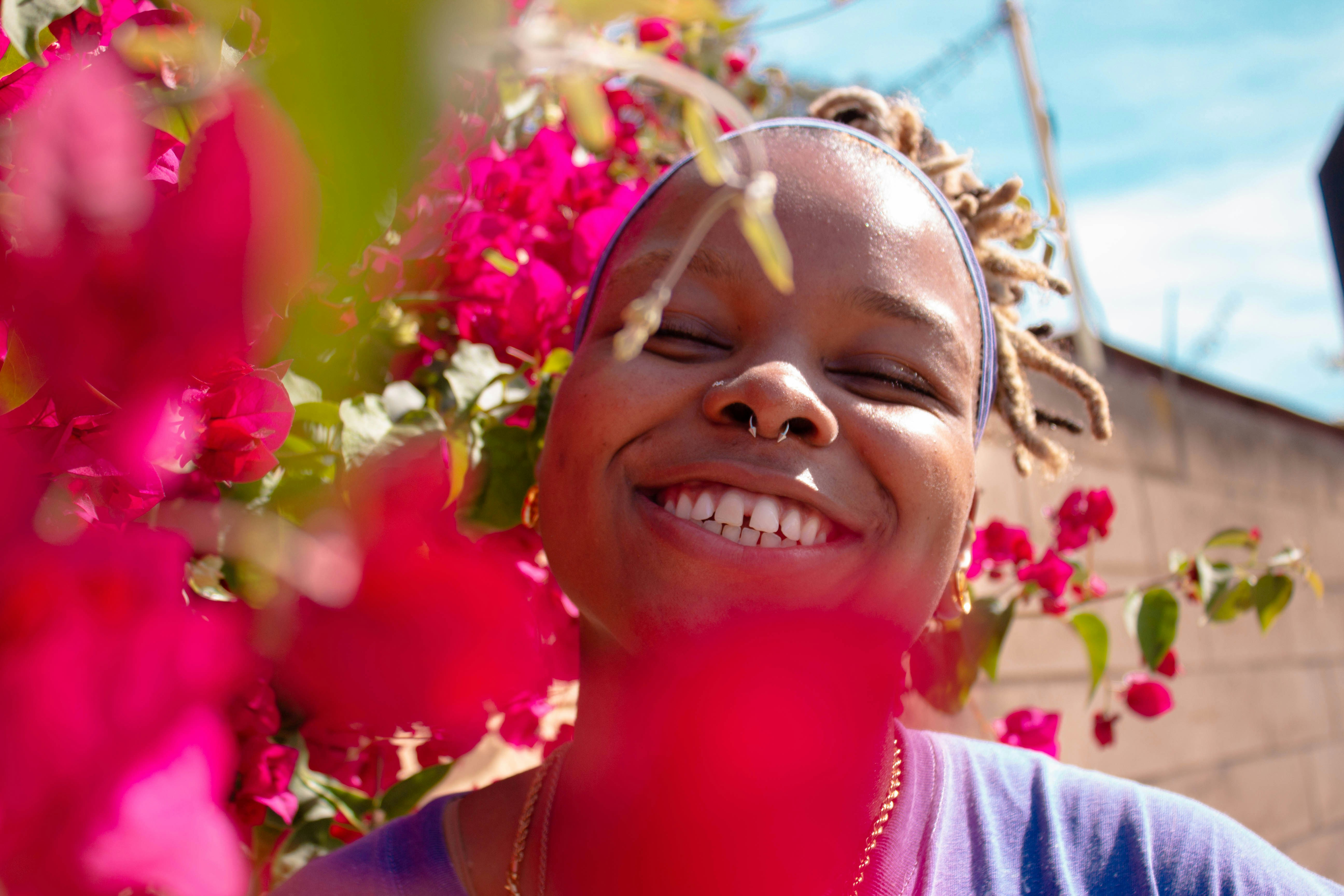 smiling girl in pink shirt with pink flower crown