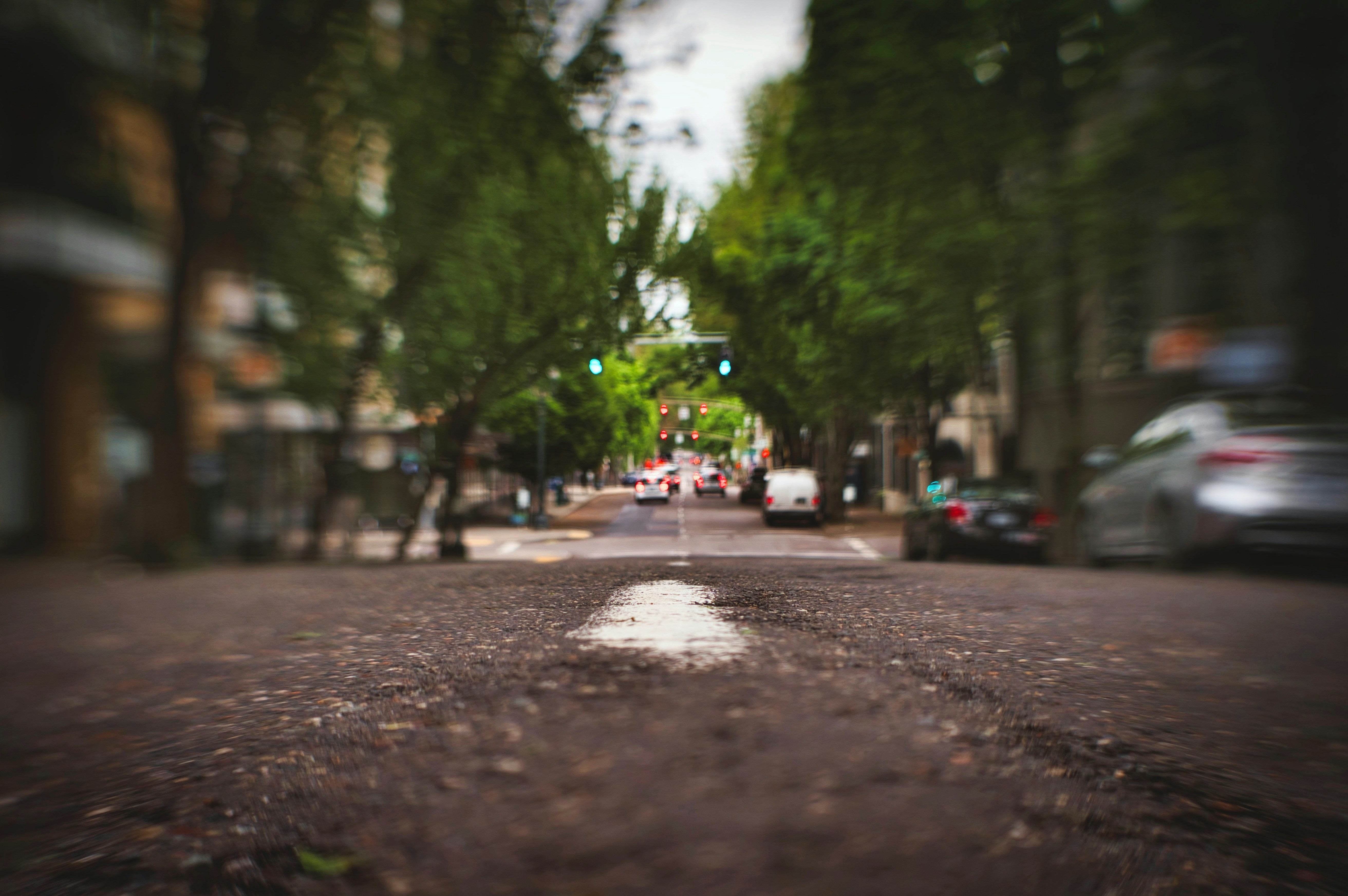 Vanishing Line: A Low-Angle Street Toward the City’s Green Light