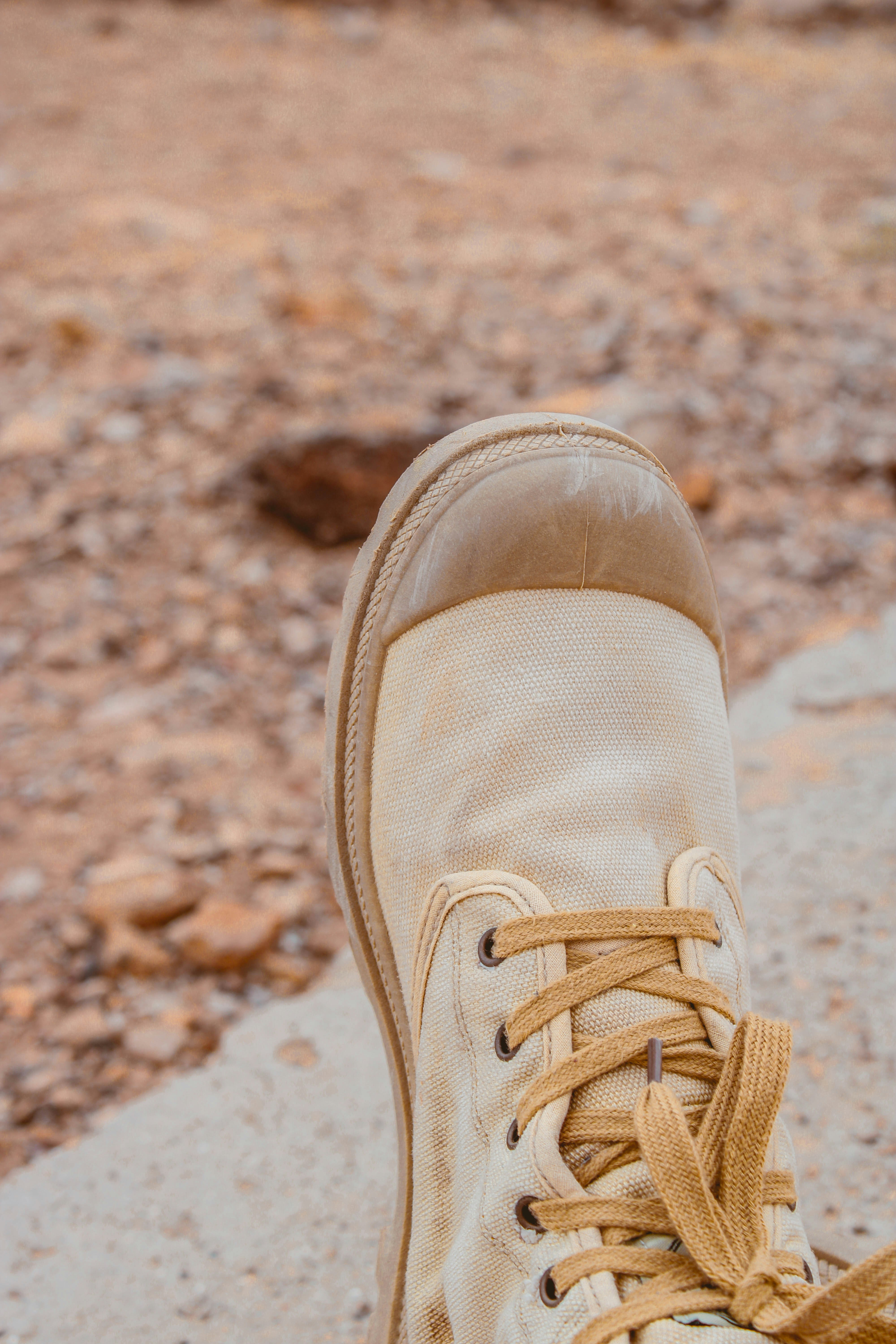 person wearing brown lace up shoe