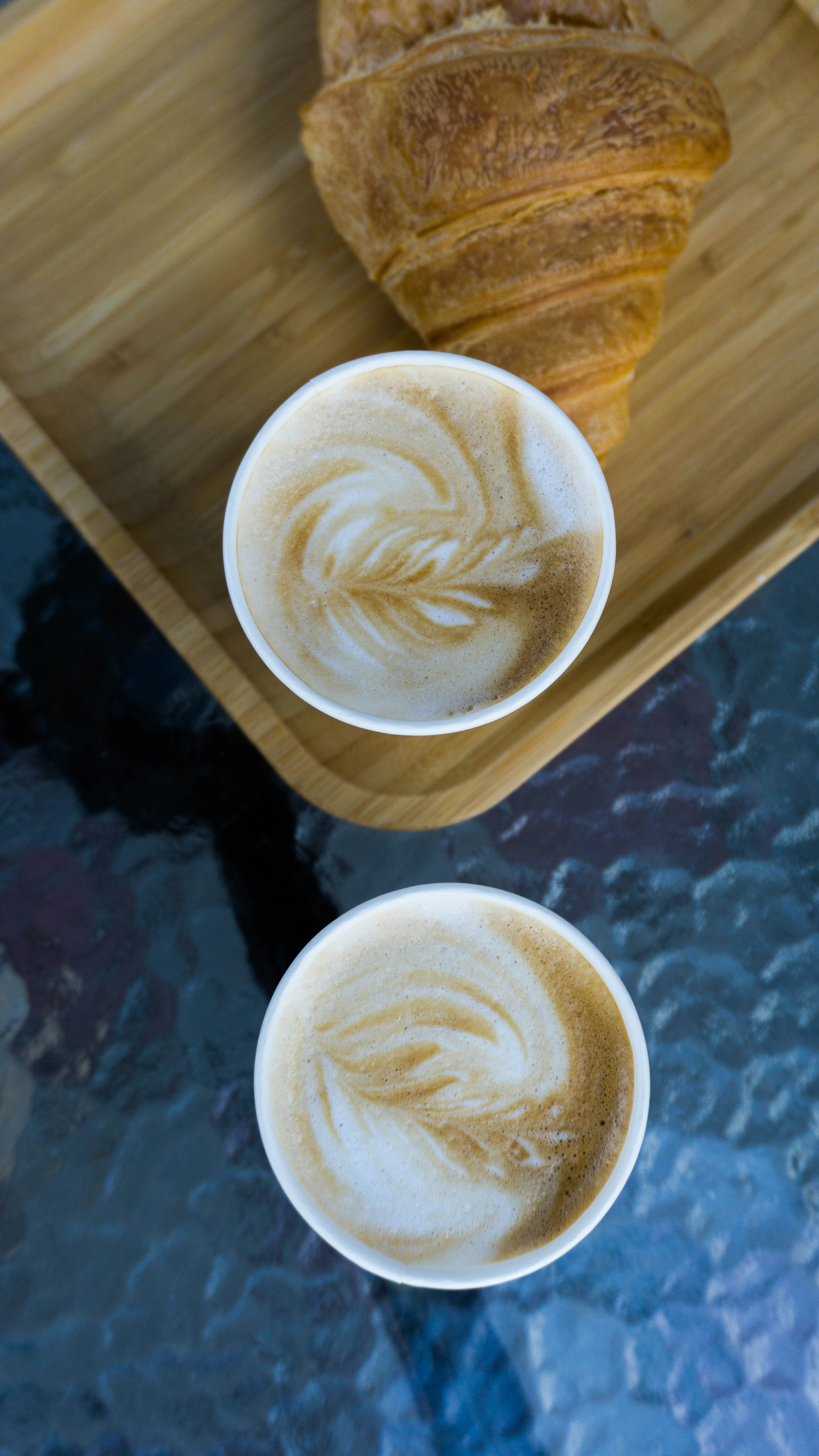Rosette Duet on Wood: Latte Art and a Croissant Moment