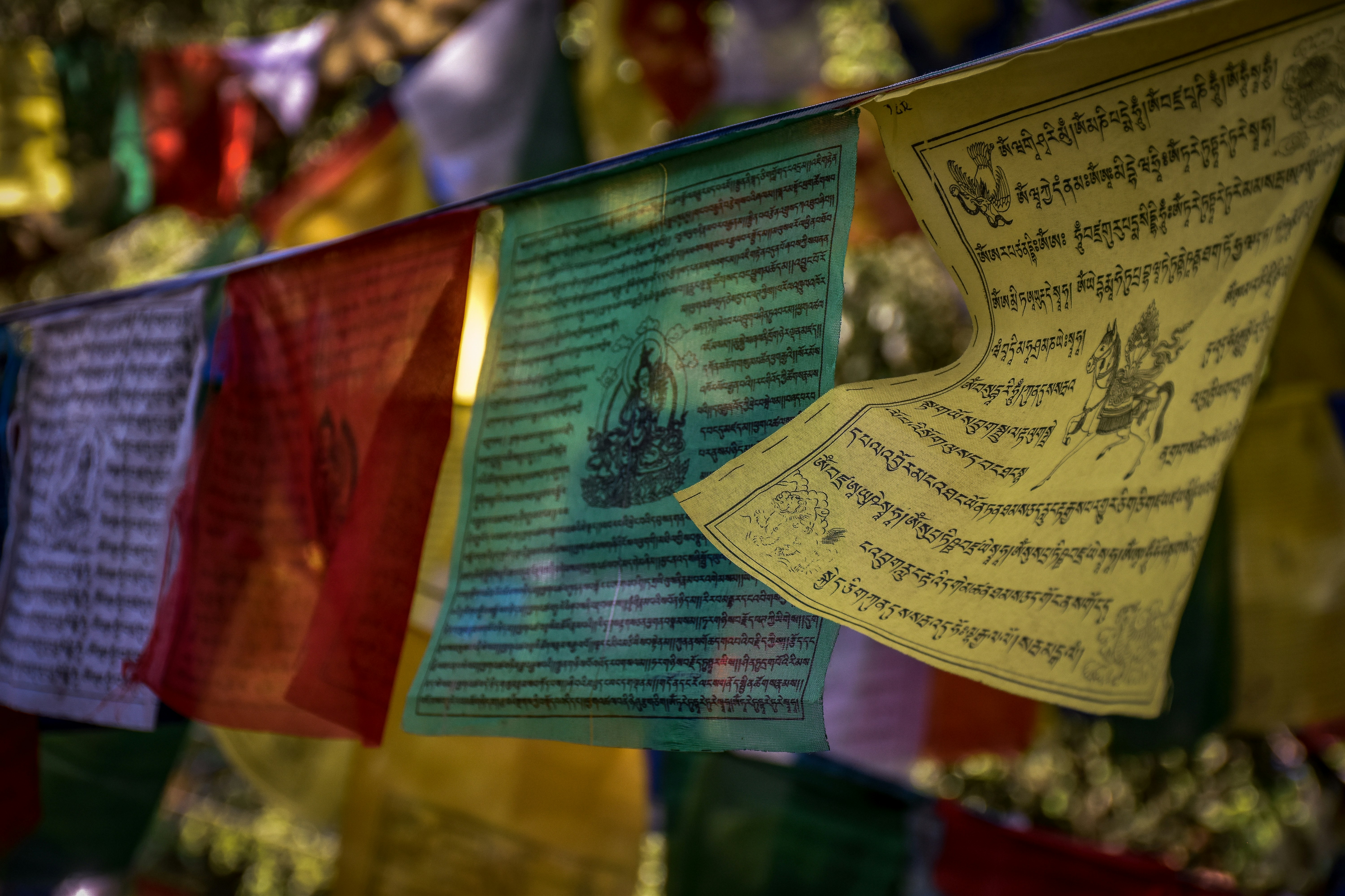 Whispered prayers in colored breeze: prayer flags fluttering in sunlight