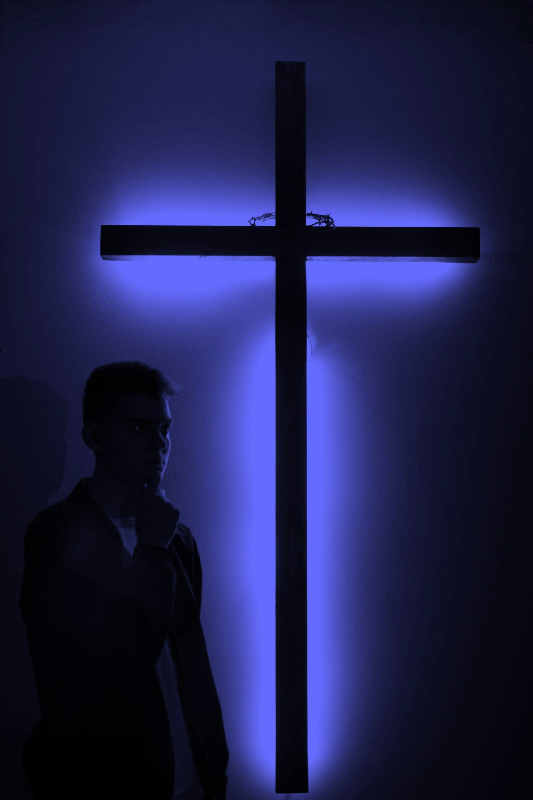 Indigo Halo: The Silent Cross Over a Shadowed Contemplation
