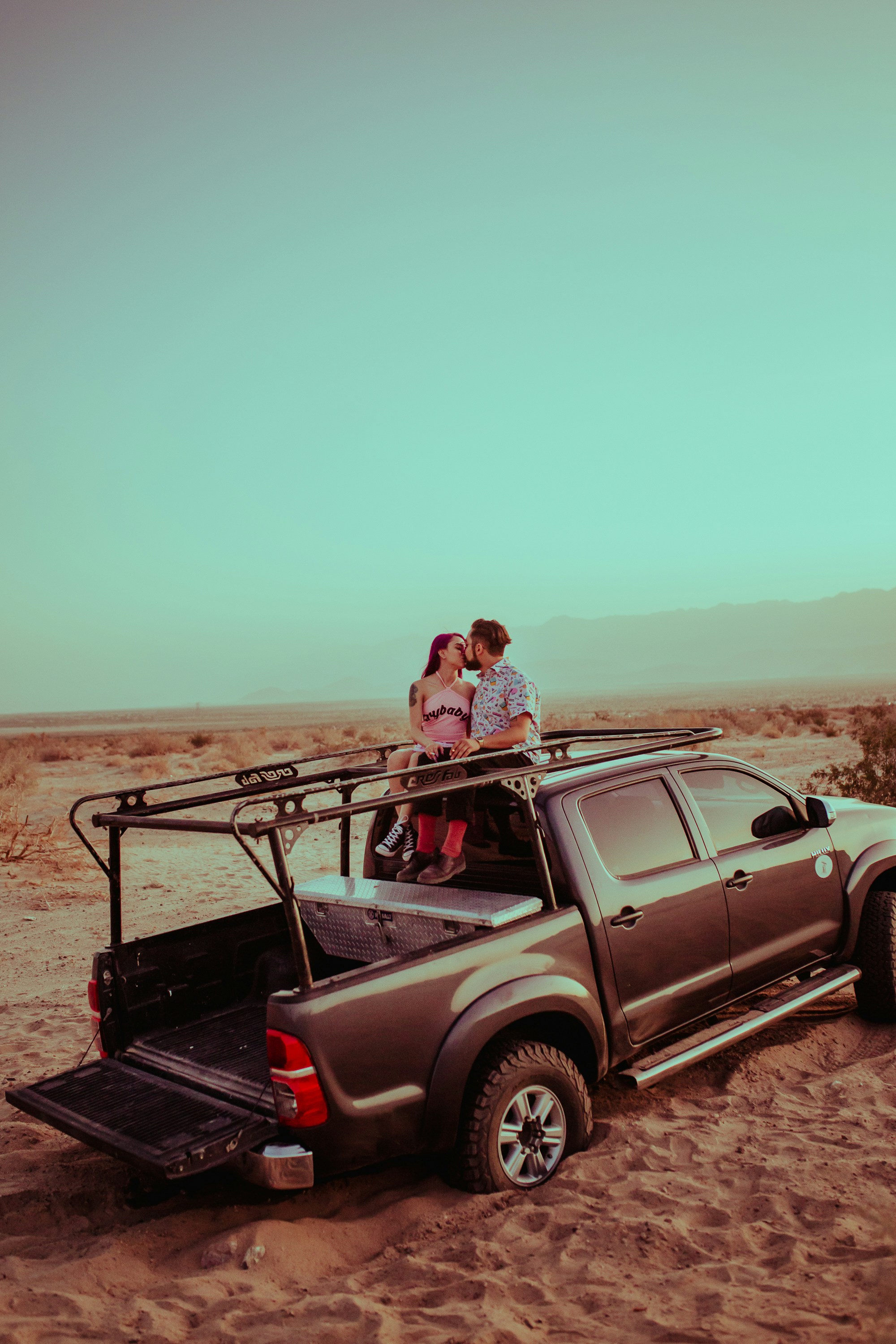 Desert Sunset Embrace on a Pickup Roof