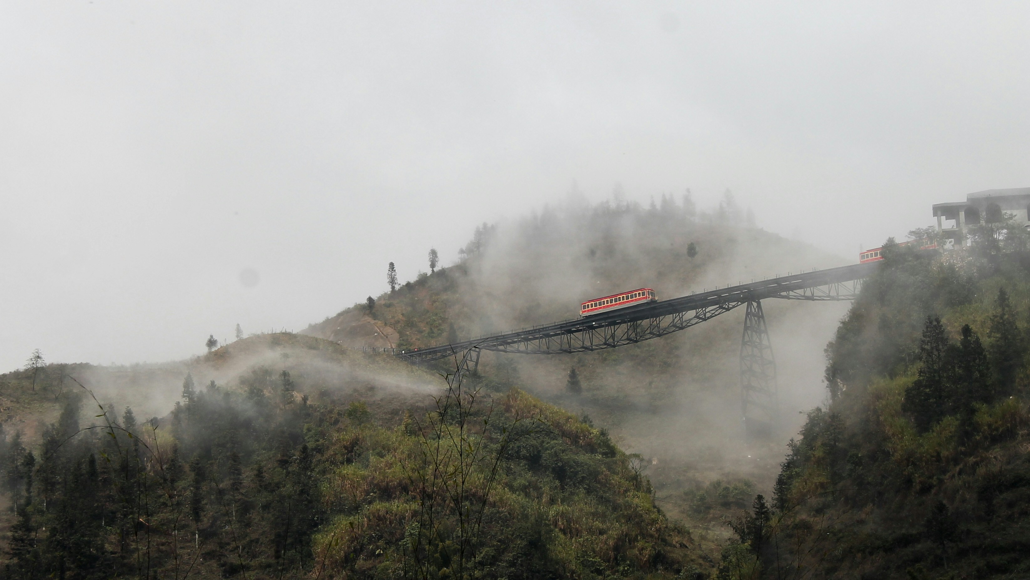 Mist-Laced Bridge Across a Veiled Ridge