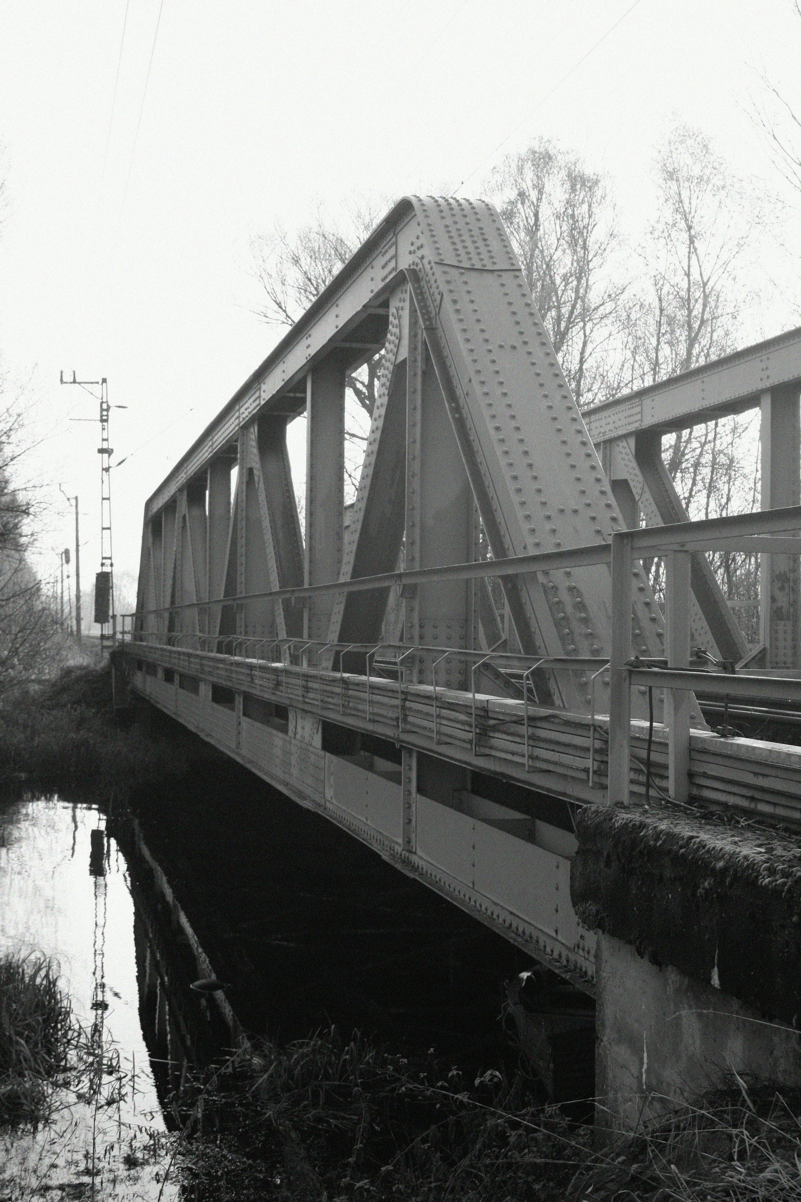 grayscale photo of bridge over river