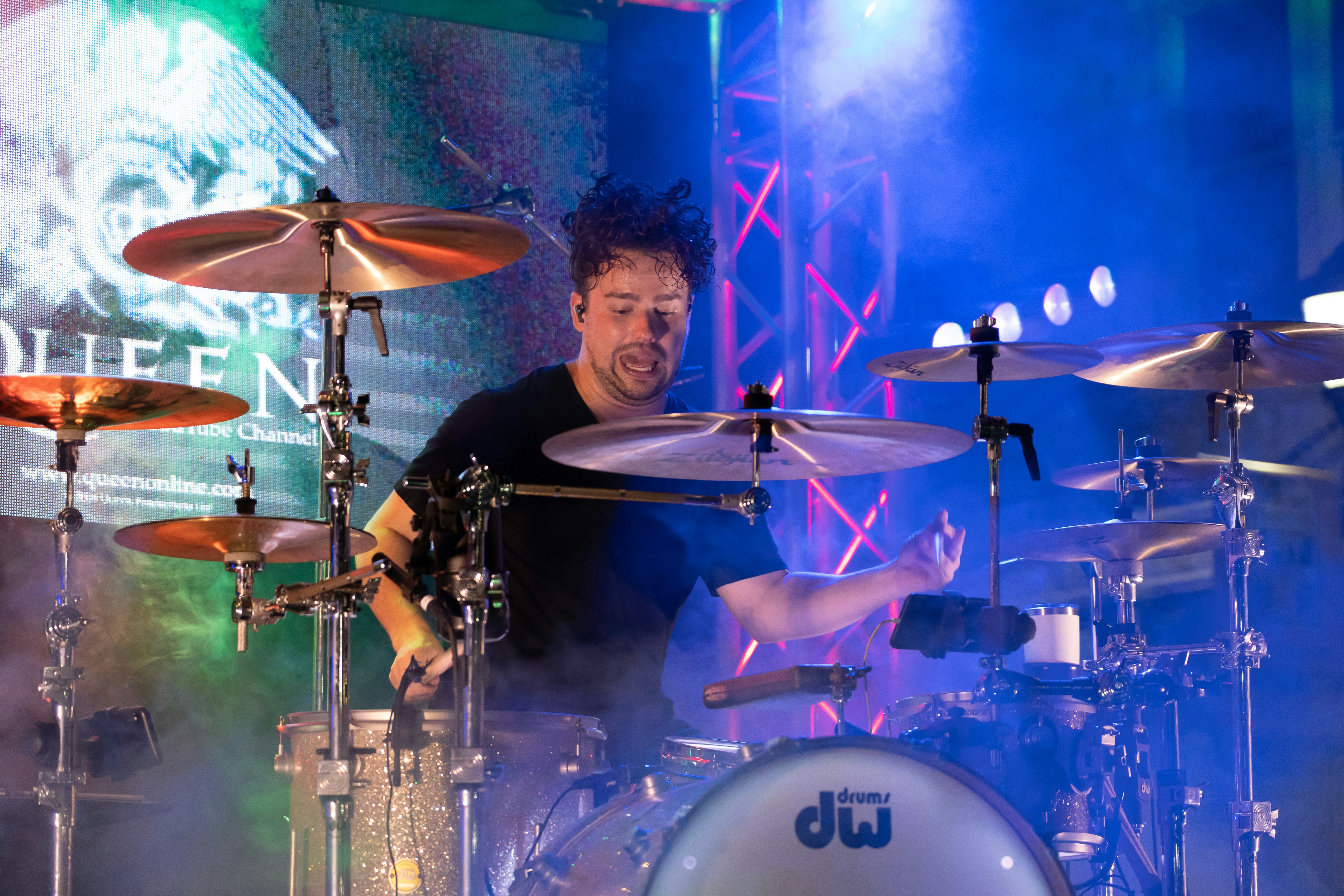 Neon Pulse on Stage: Drummer Commands a Smoke-Wrapped Drum Kit
